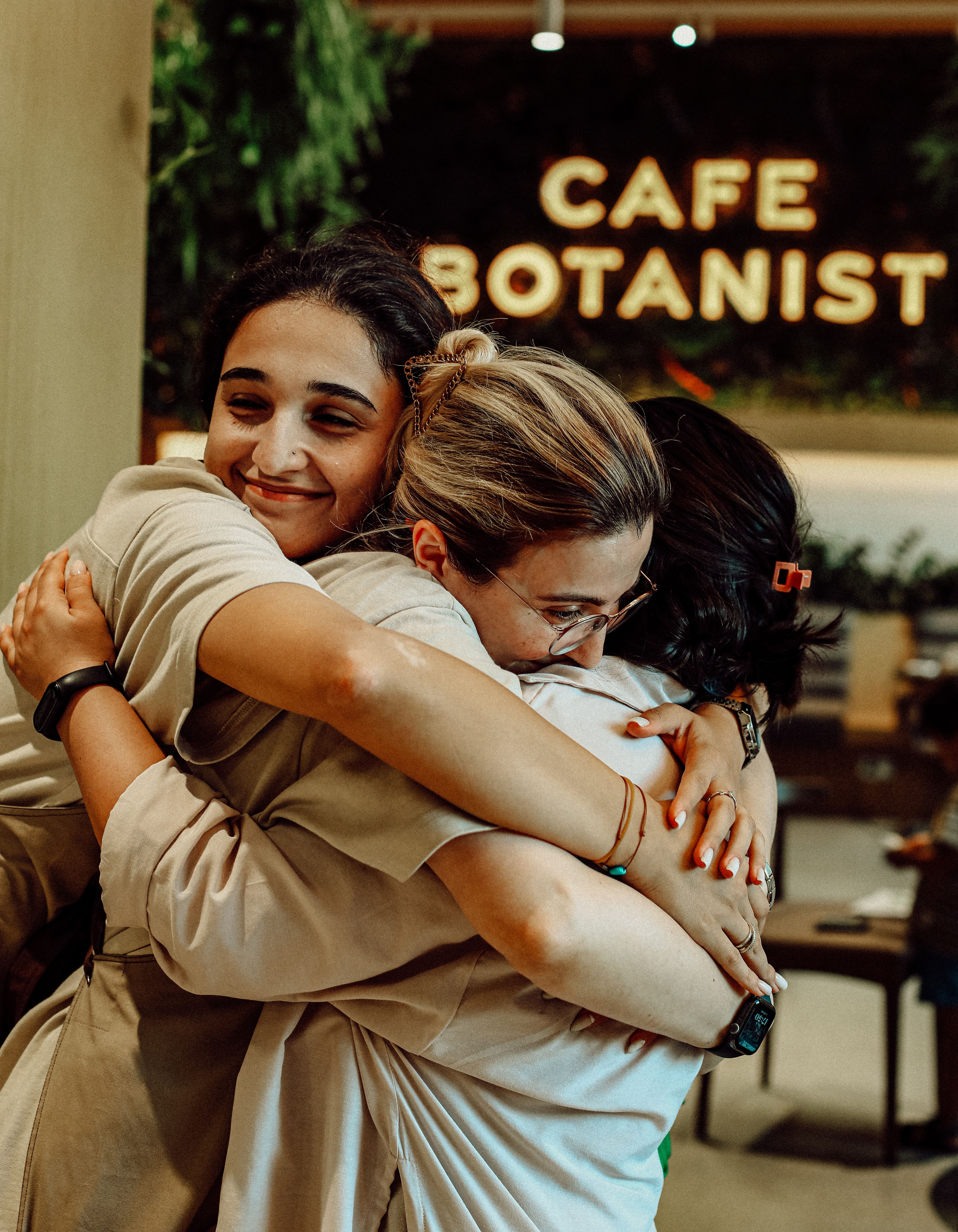Women Hugging in Cafe · Free Stock Photo