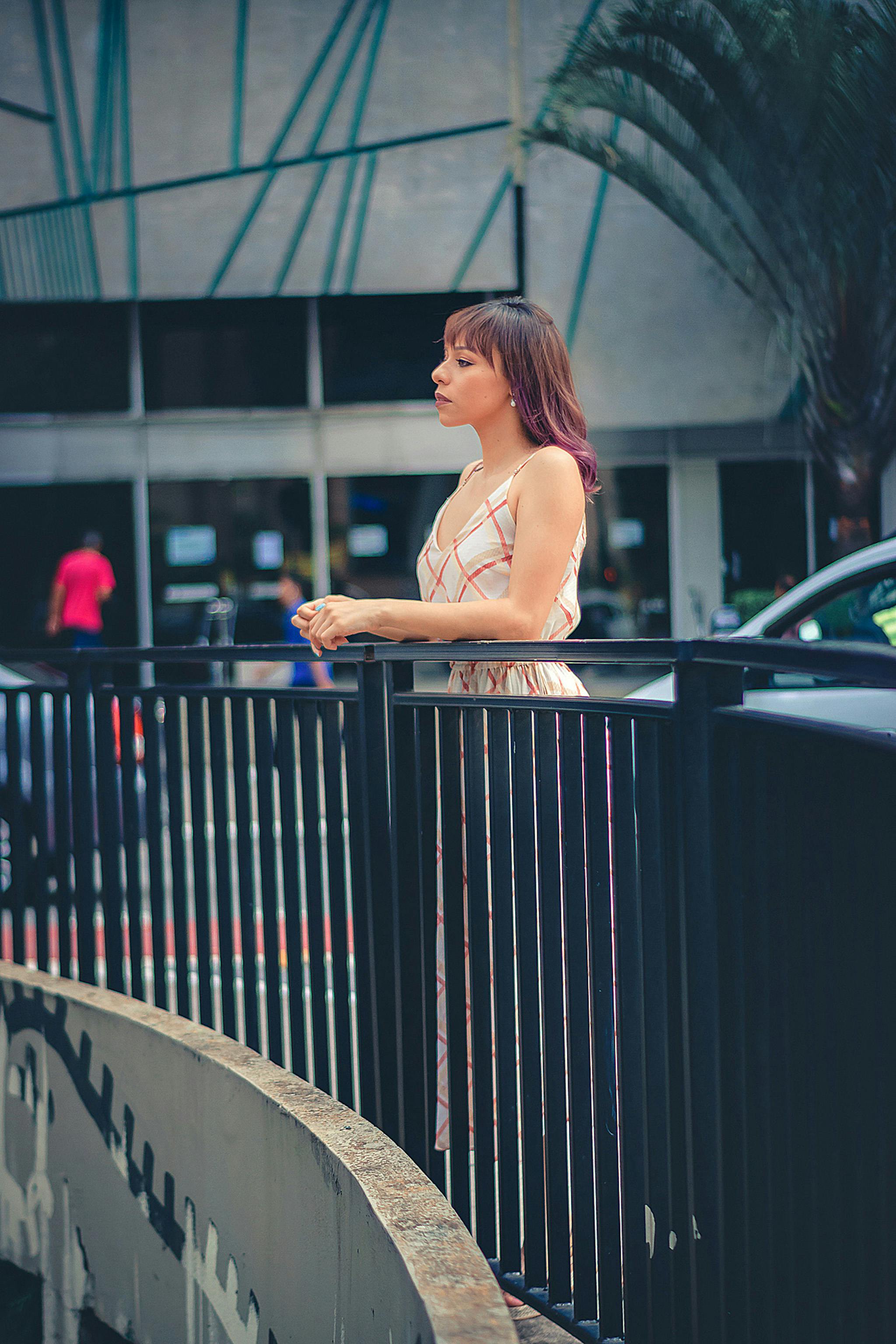 Woman Leaning on a Railing · Free Stock Photo