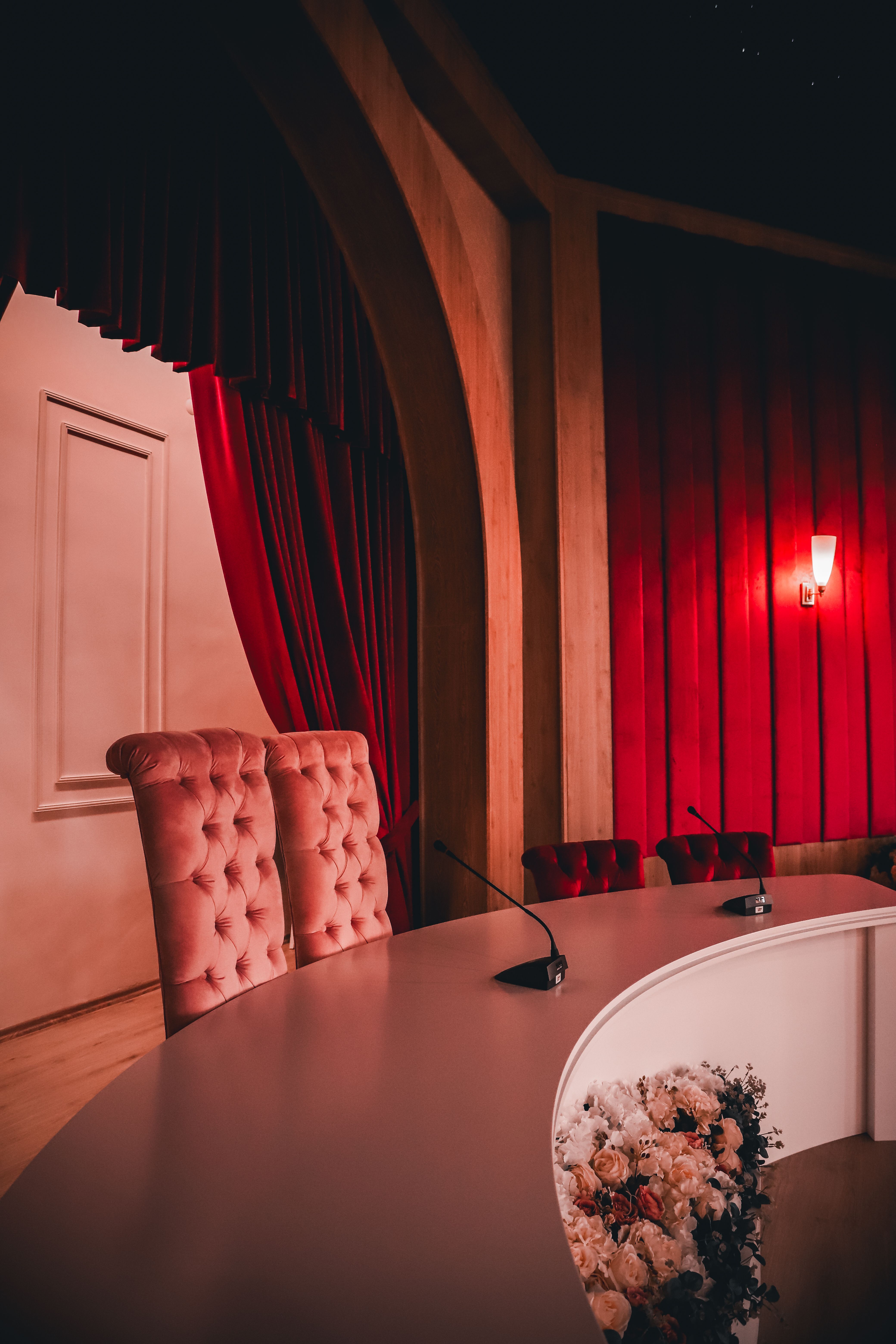 A red curtain and a table in front of a stage · Free Stock Photo