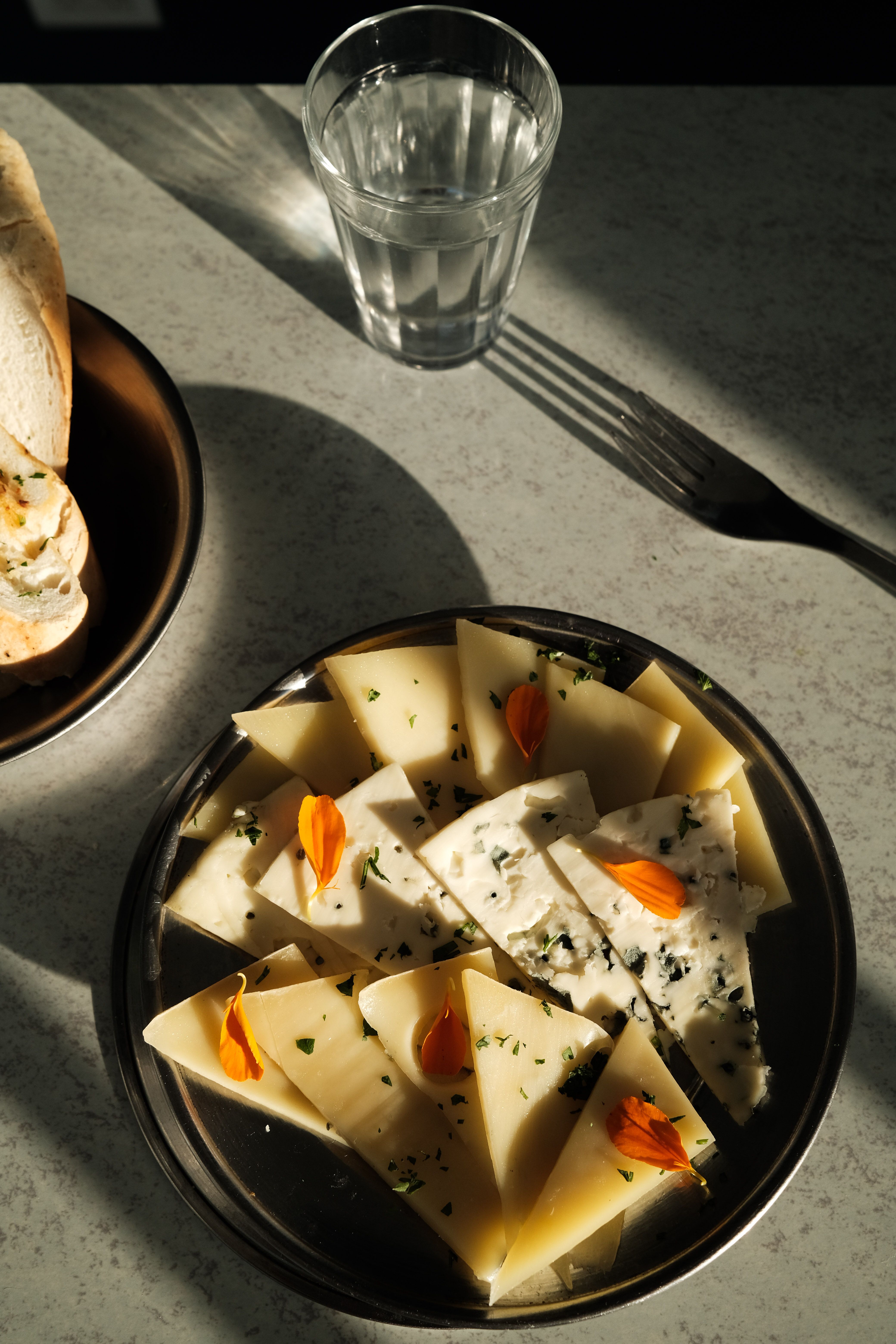Cheese on Plate and Glass of Water near · Free Stock Photo