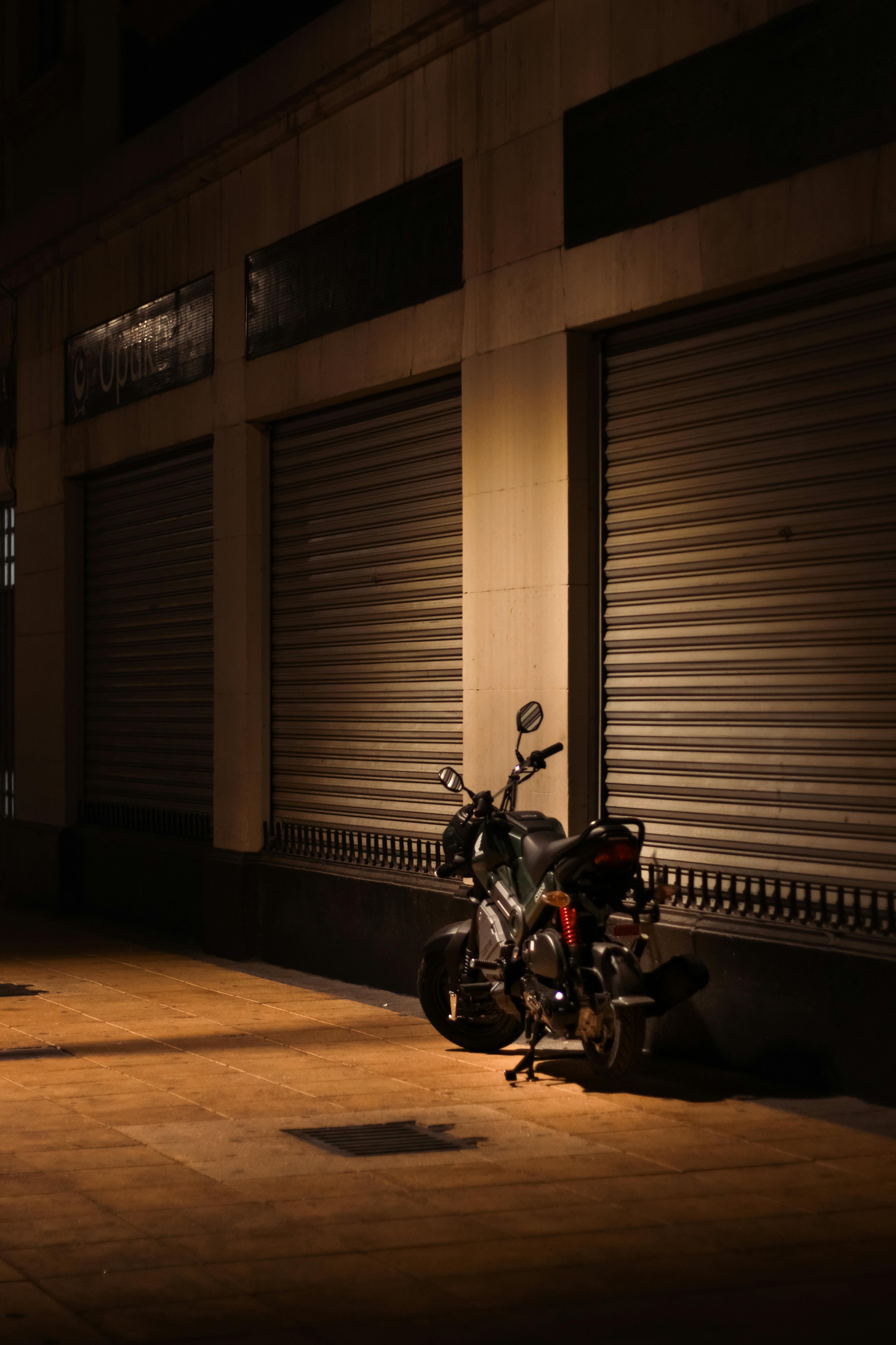 Motorcycle Parked near Building at Night · Free Stock Photo