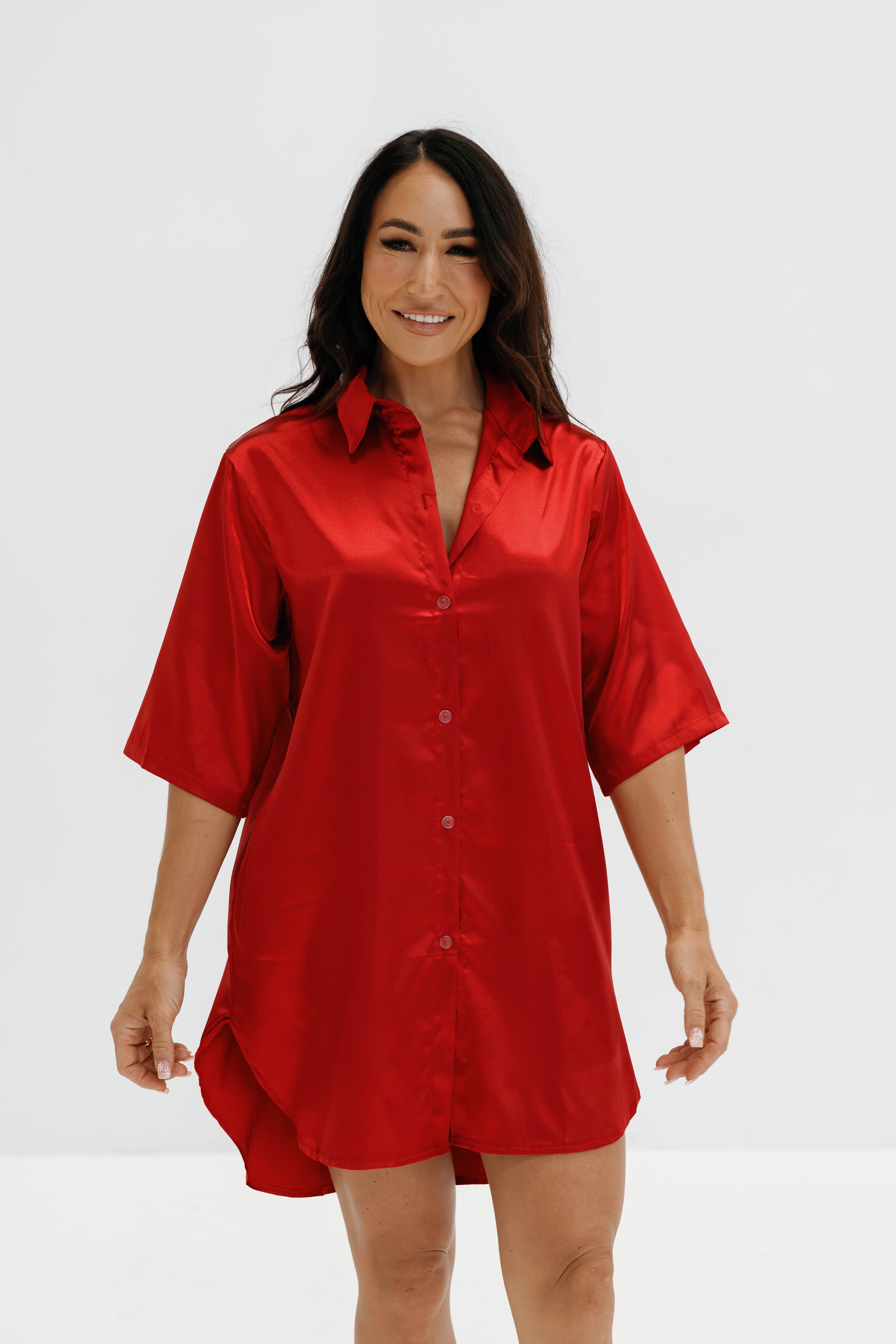 The red shirt dress is made from a soft satin material · Free Stock Photo