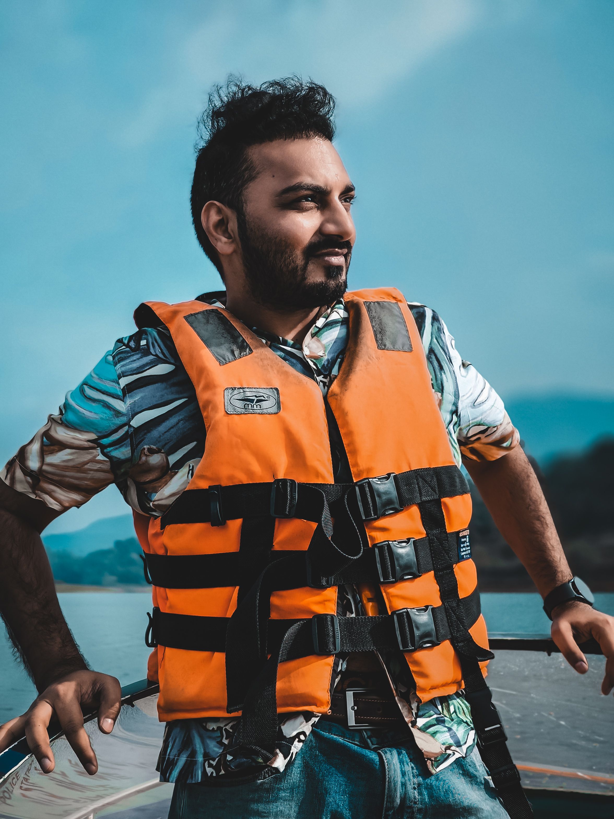 A Man Wearing a Life Jacket Standing on a Boat · Free Stock Photo