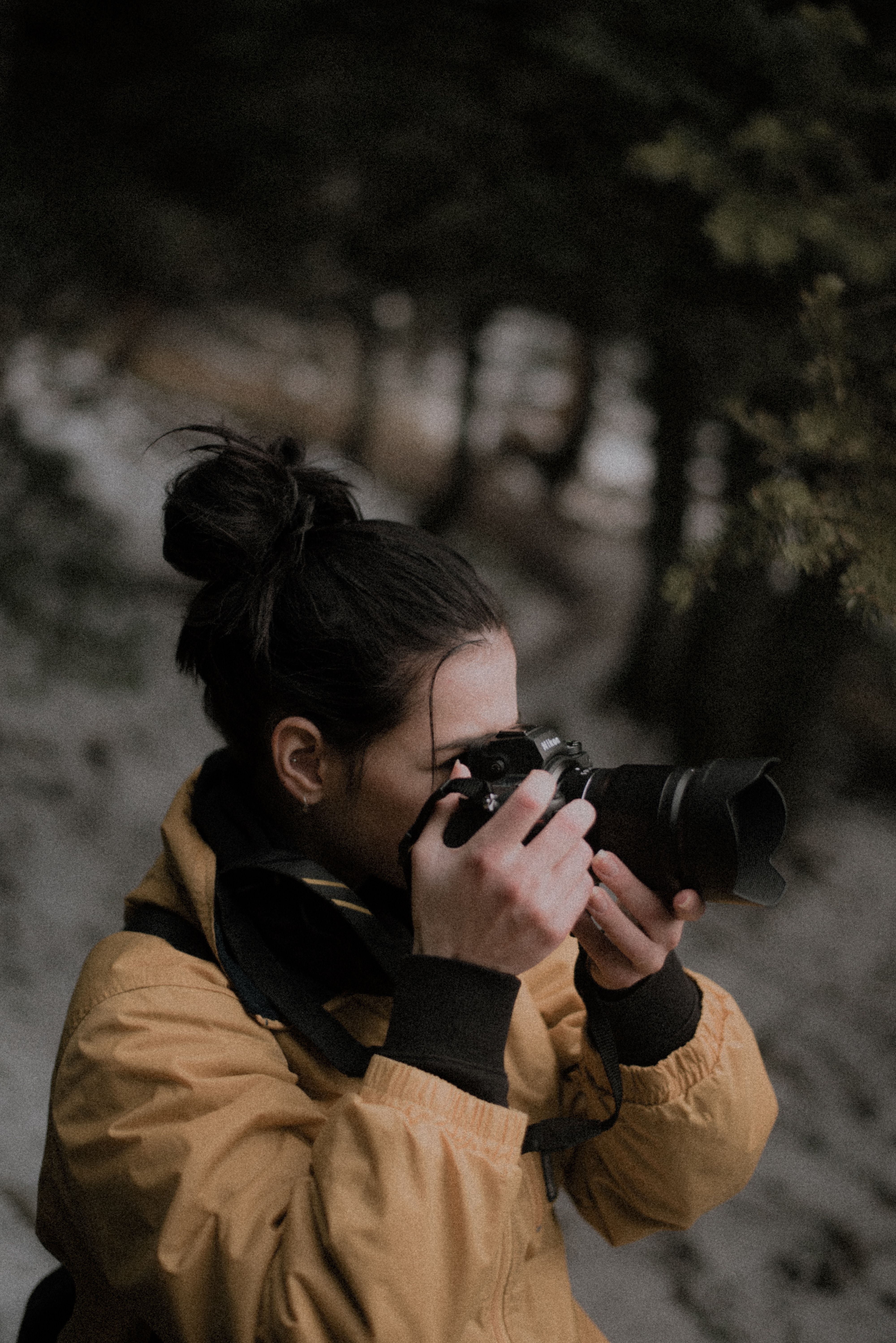 A woman taking a picture with a camera · Free Stock Photo