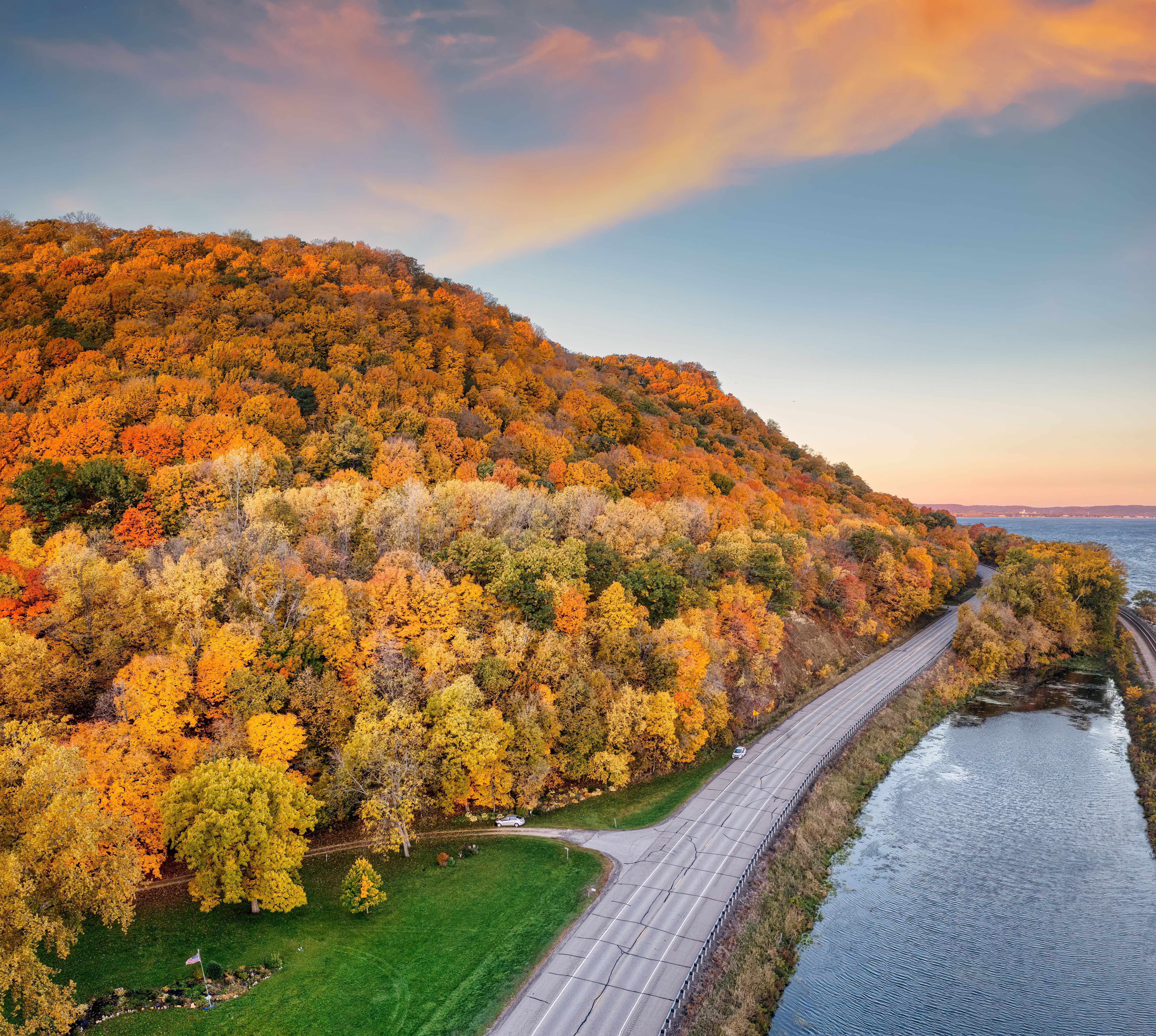 Aerial View of a Road Running along a Hill with Autumnal Trees · Free ...