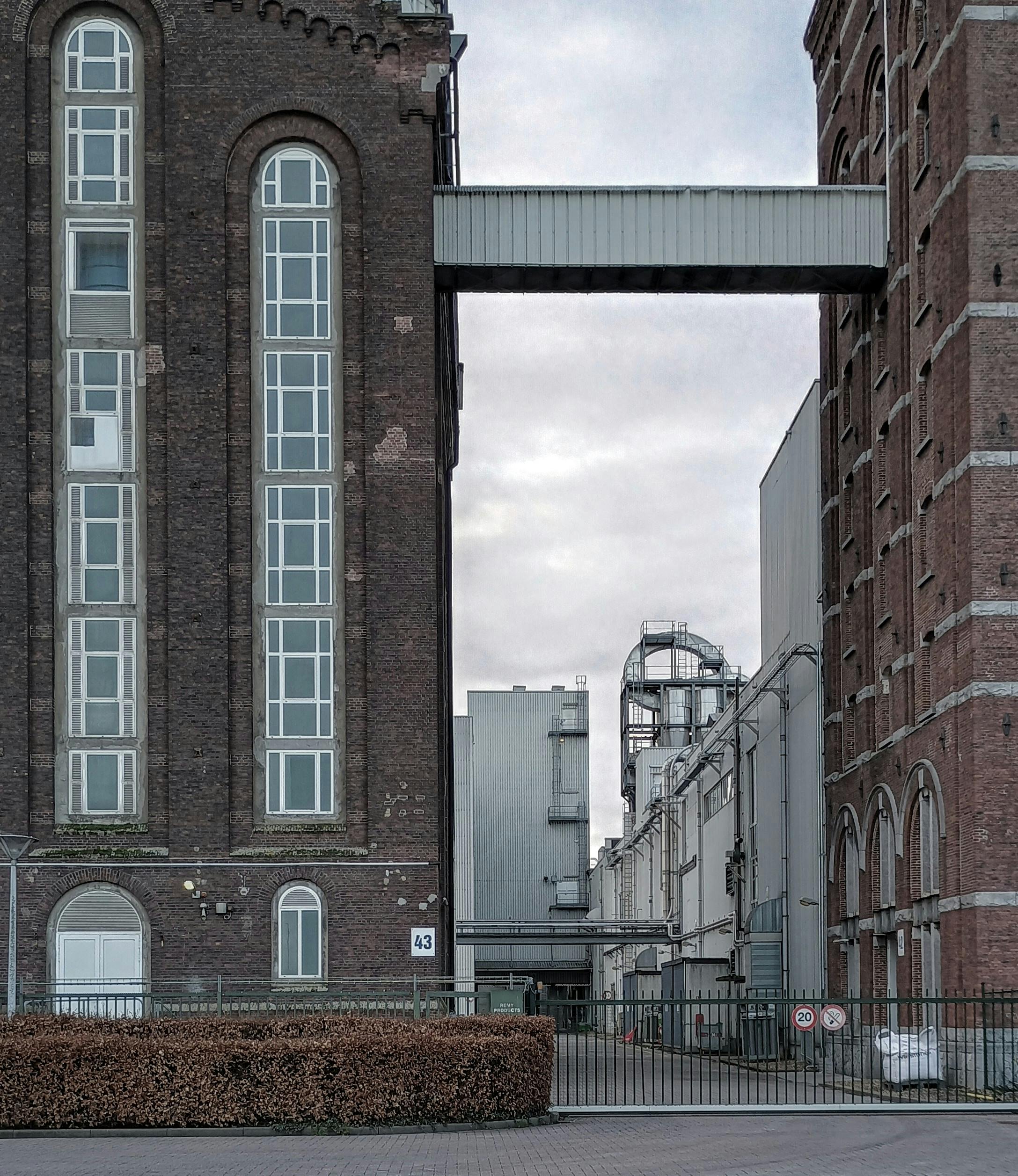 Elevated Walkway Connecting Two Industrial Buildings · Free Stock Photo