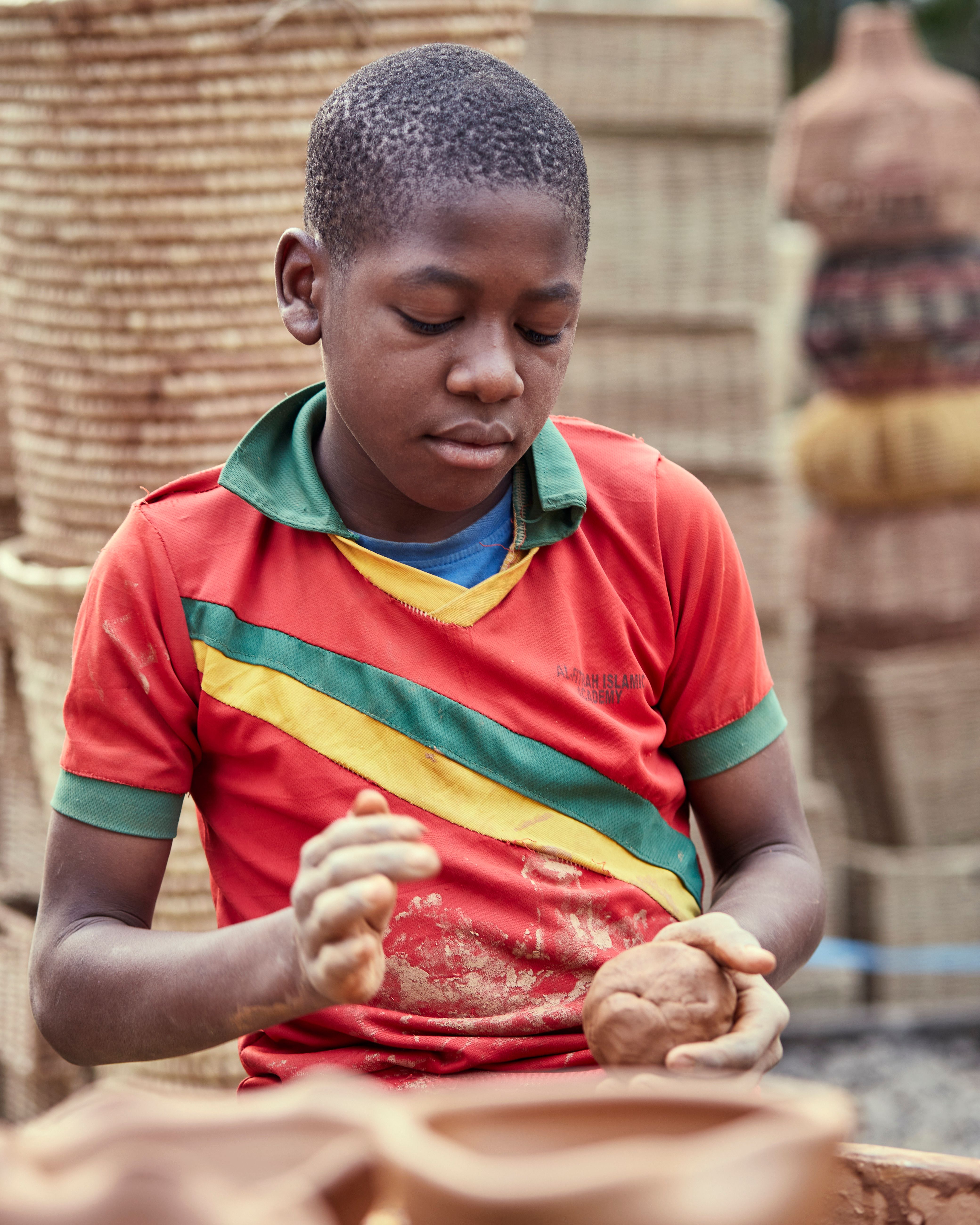 Boy Making Clay Pots on a Street · Free Stock Photo