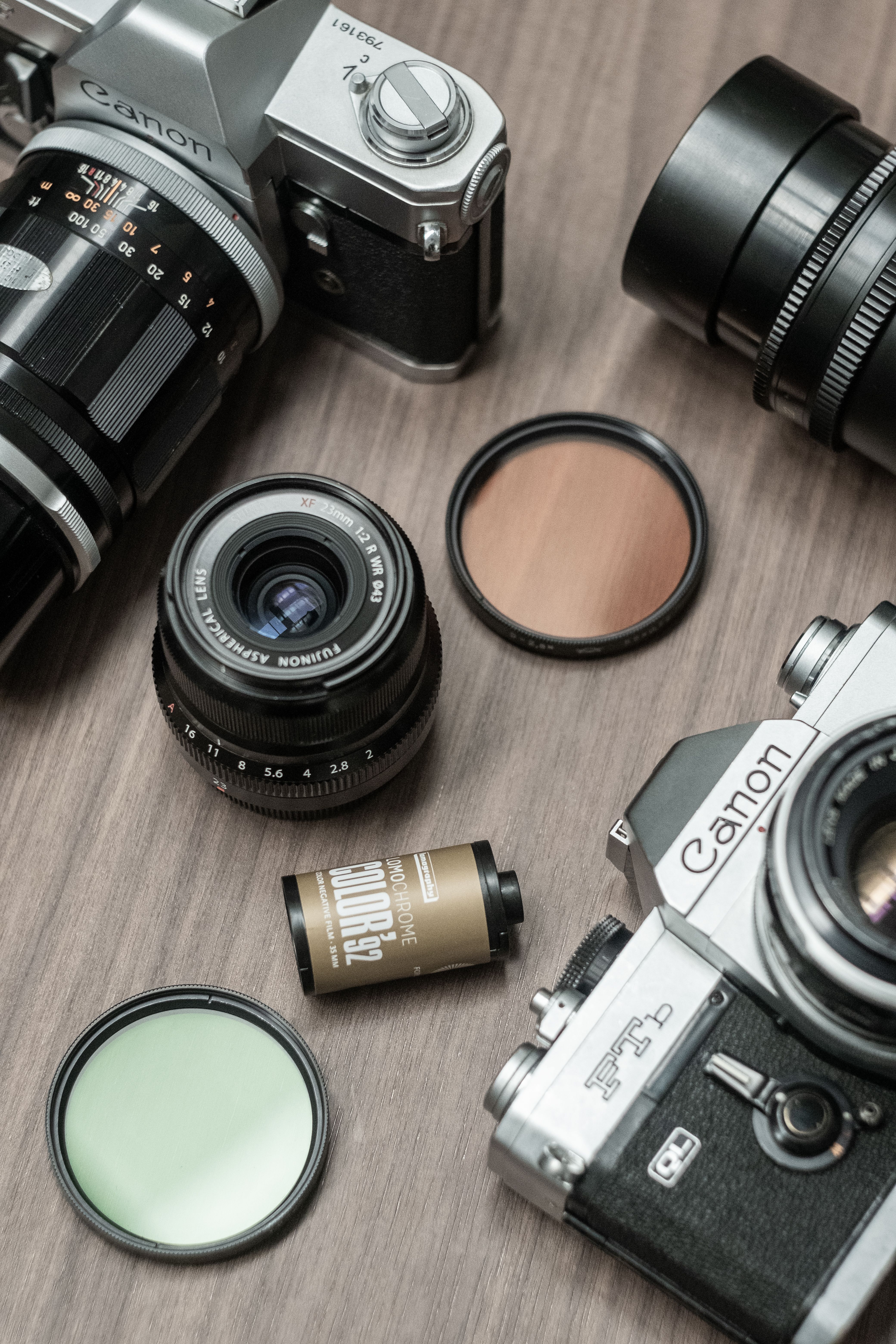 A variety of cameras and lenses on a table · Free Stock Photo