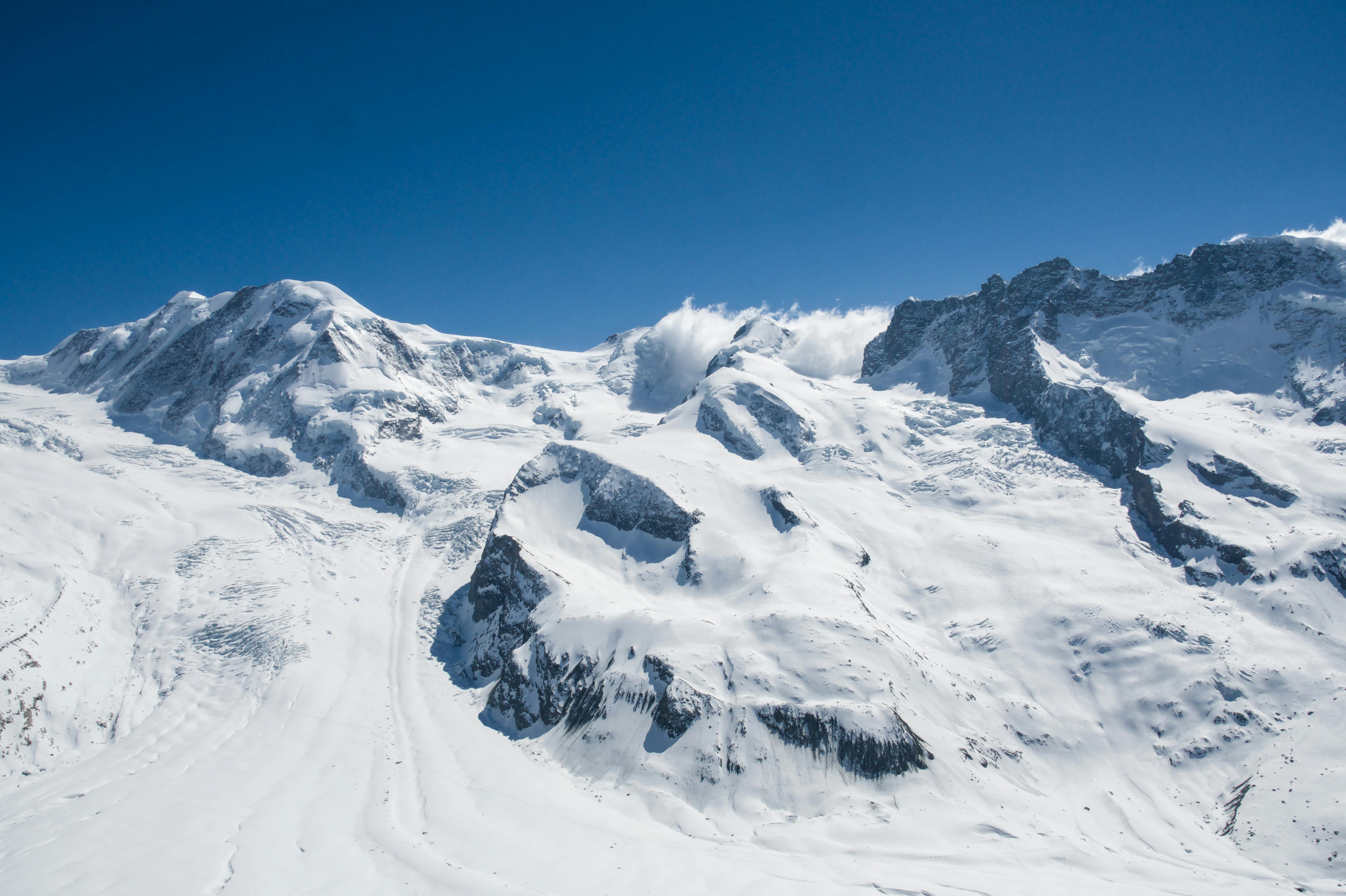 Areal Photography Of Snow Coated Mountains Under Clear Blue Sky · Free ...