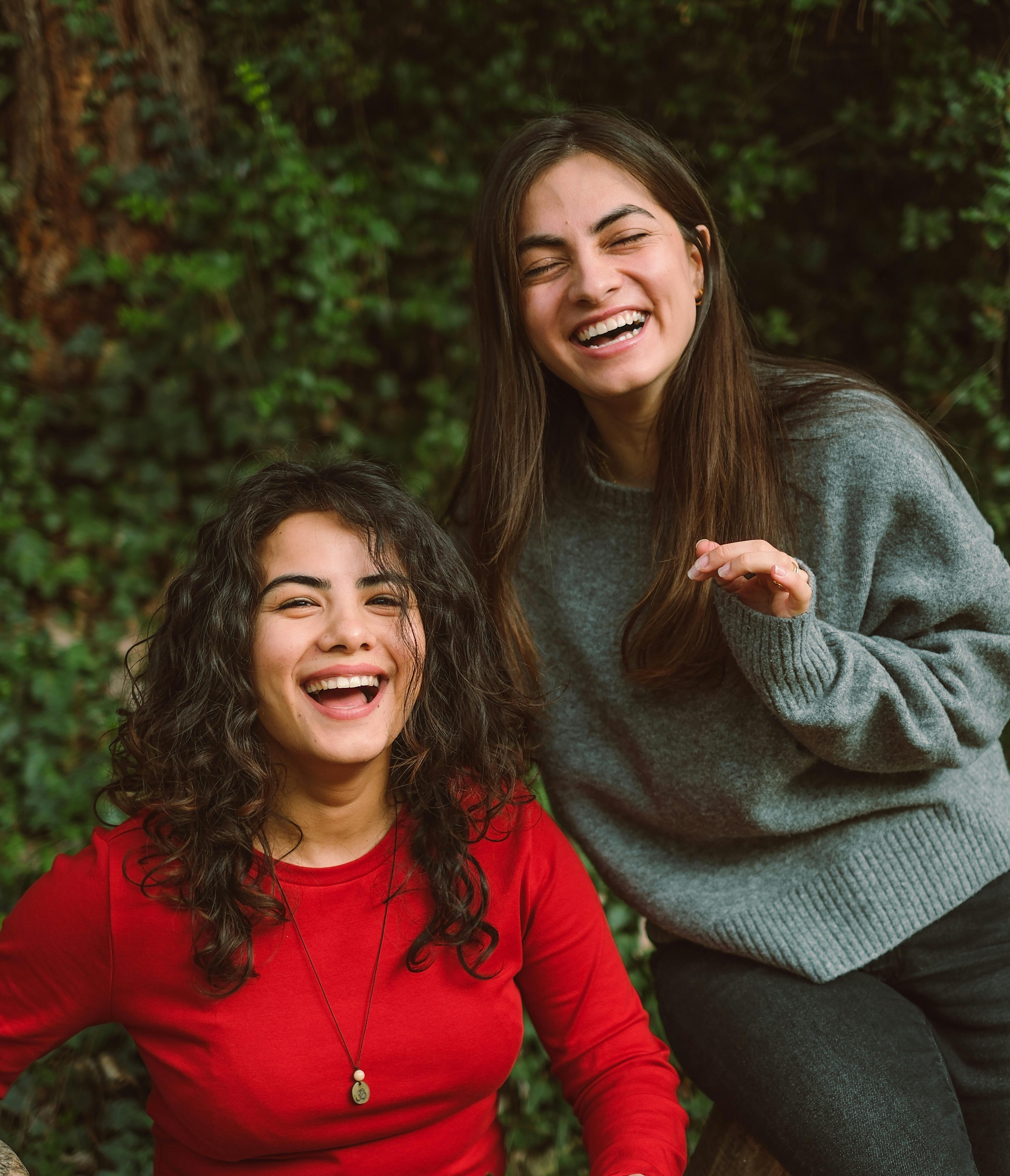 Two women laughing and smiling for the camera · Free Stock Photo