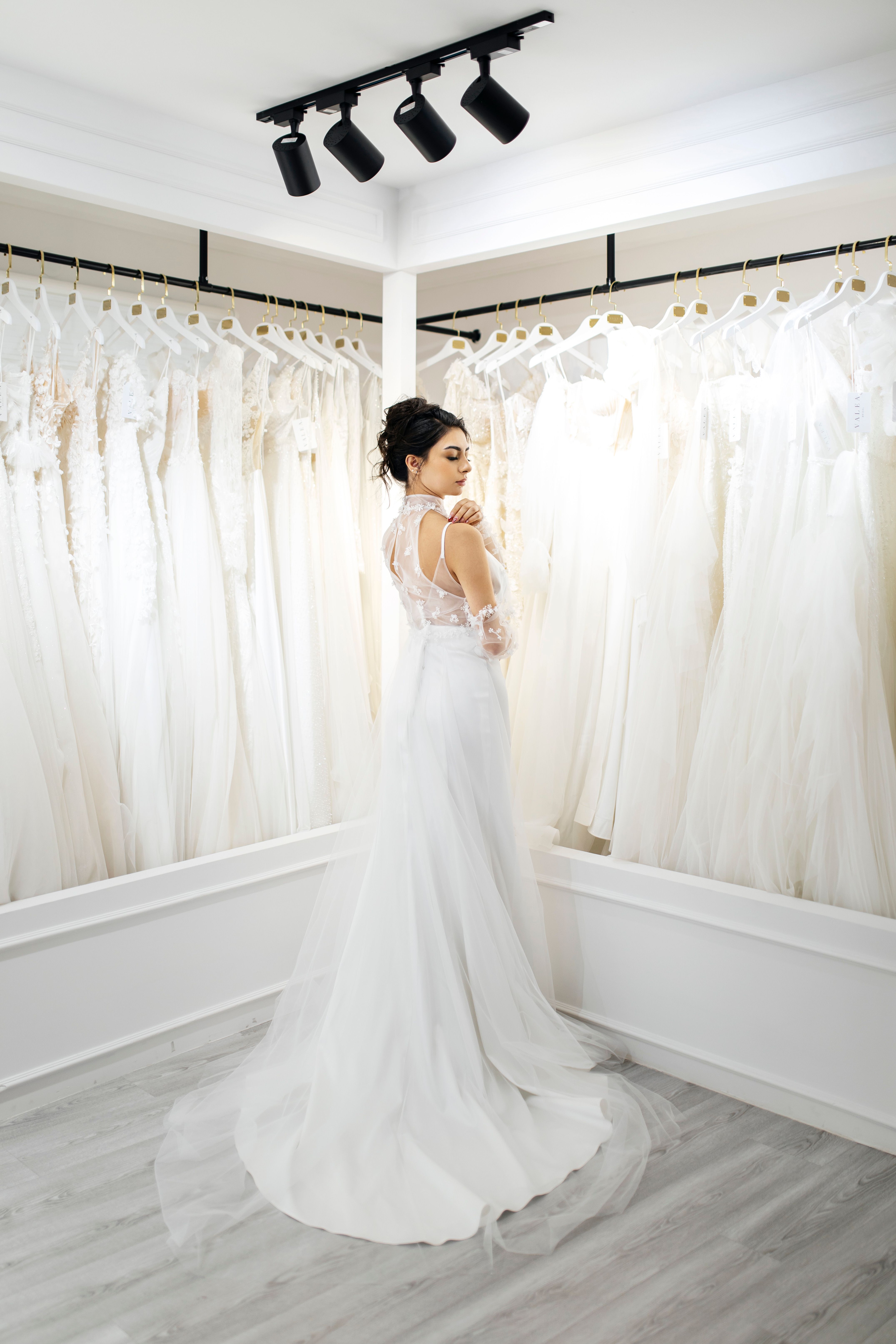 Woman in a Wedding Dress Posing in a Bridal Shop · Free Stock Photo