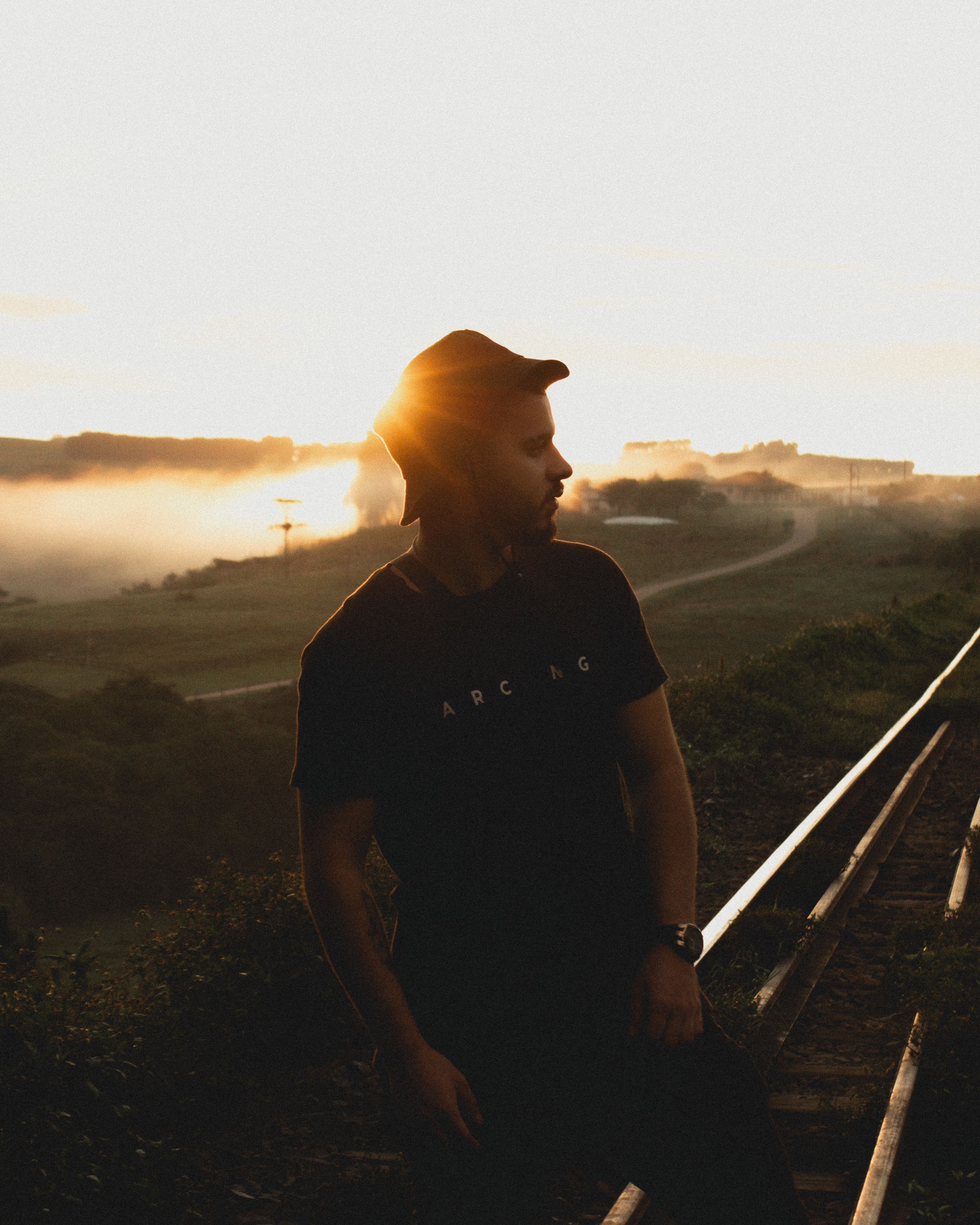 Portrait of a Man Standing against the Setting Sun · Free Stock Photo