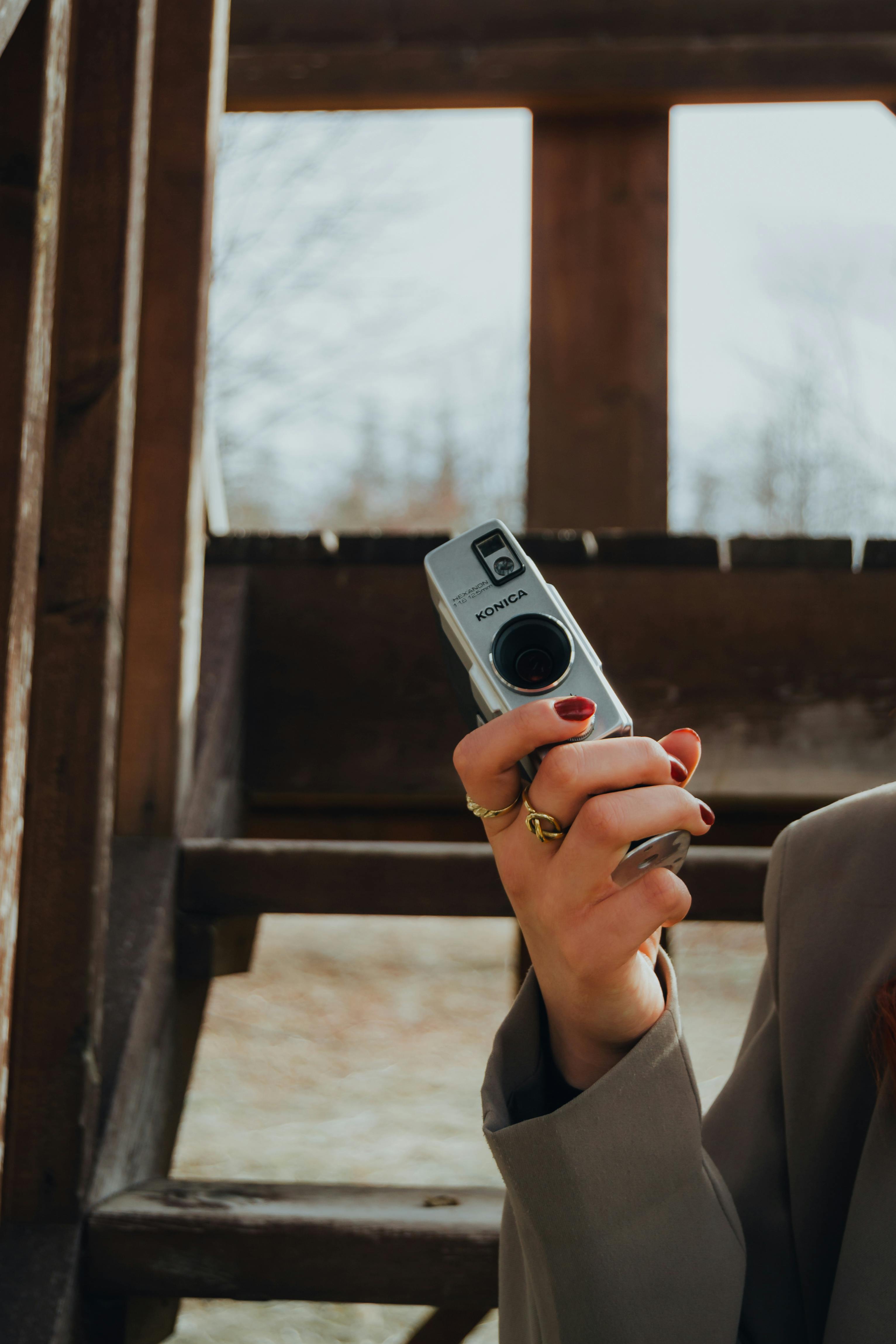 Woman Hand Holding Camera · Free Stock Photo