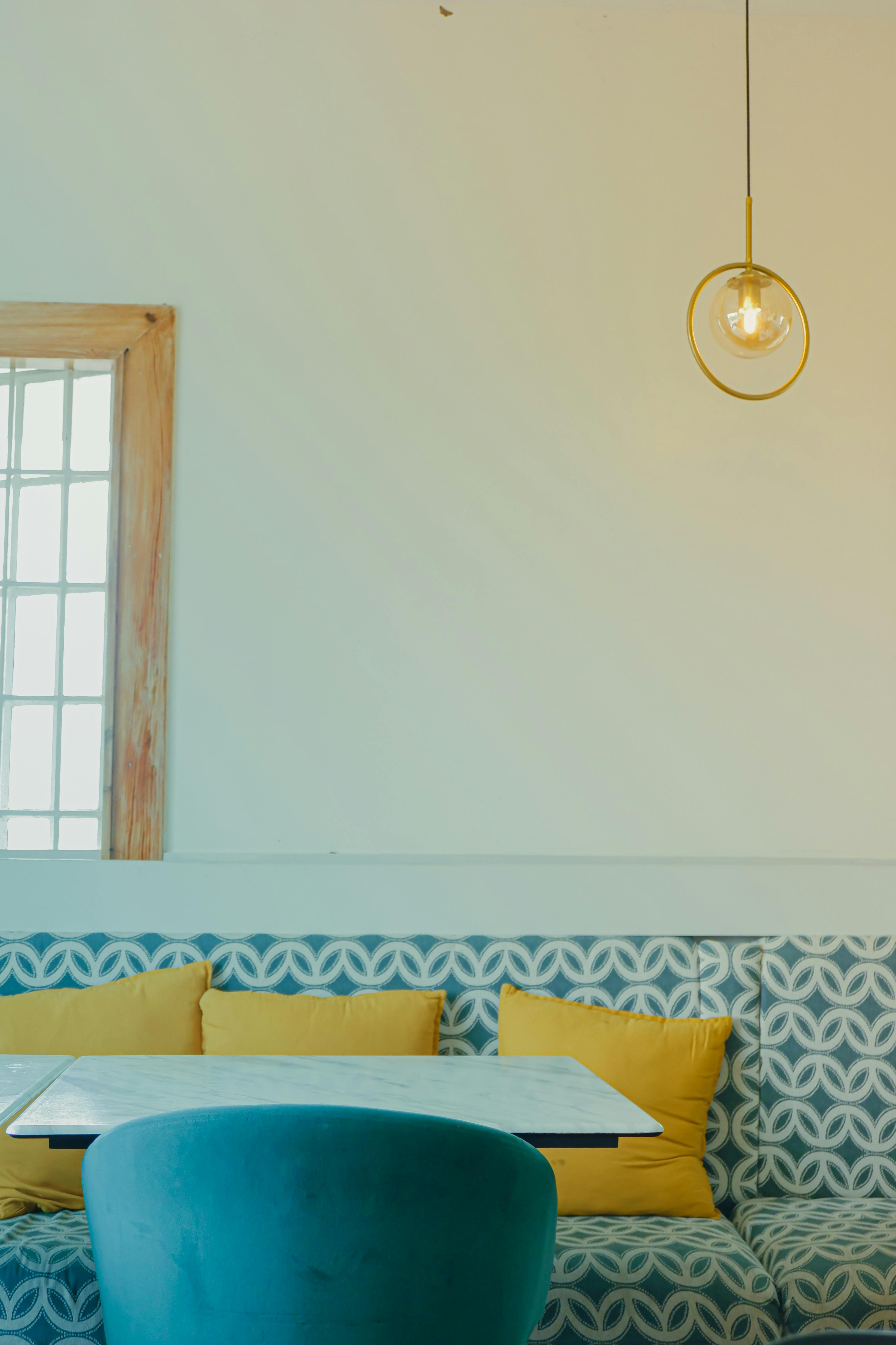 Lamp over Table and Couch with Pillows · Free Stock Photo