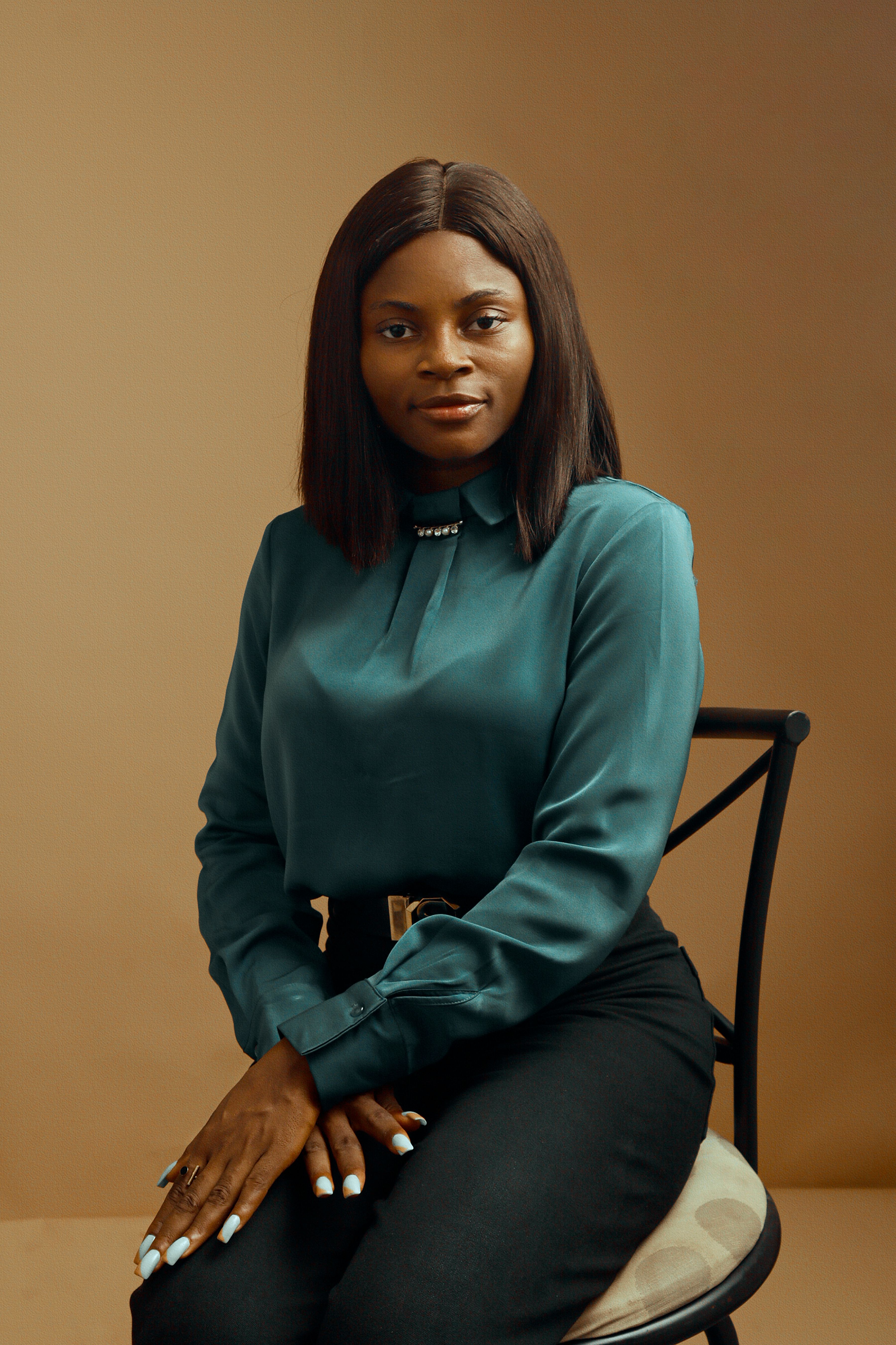 Studio Shot of an Elegant Woman Sitting on a Chair · Free Stock Photo