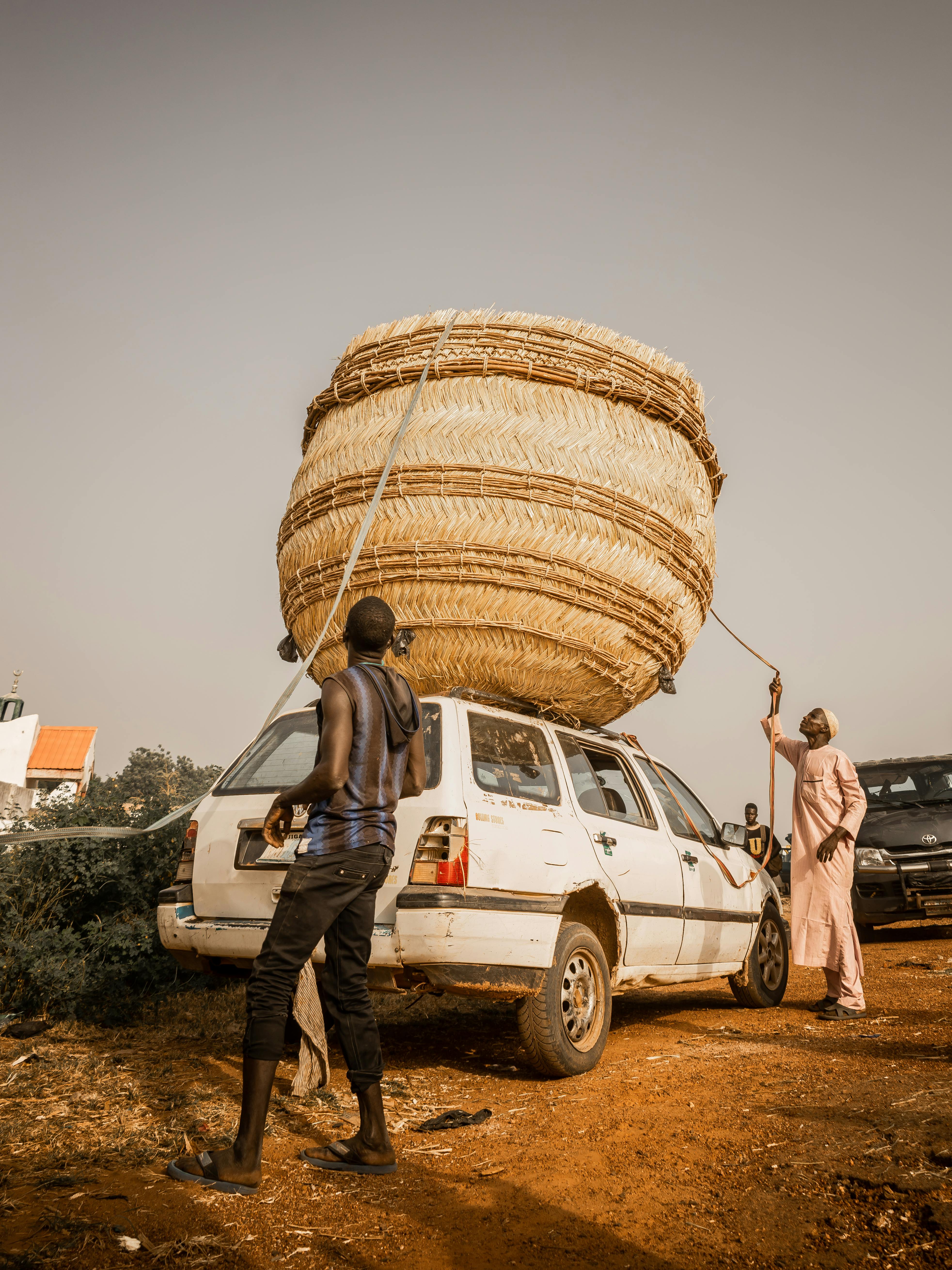 Men Transporting Large Basket with Car · Free Stock Photo