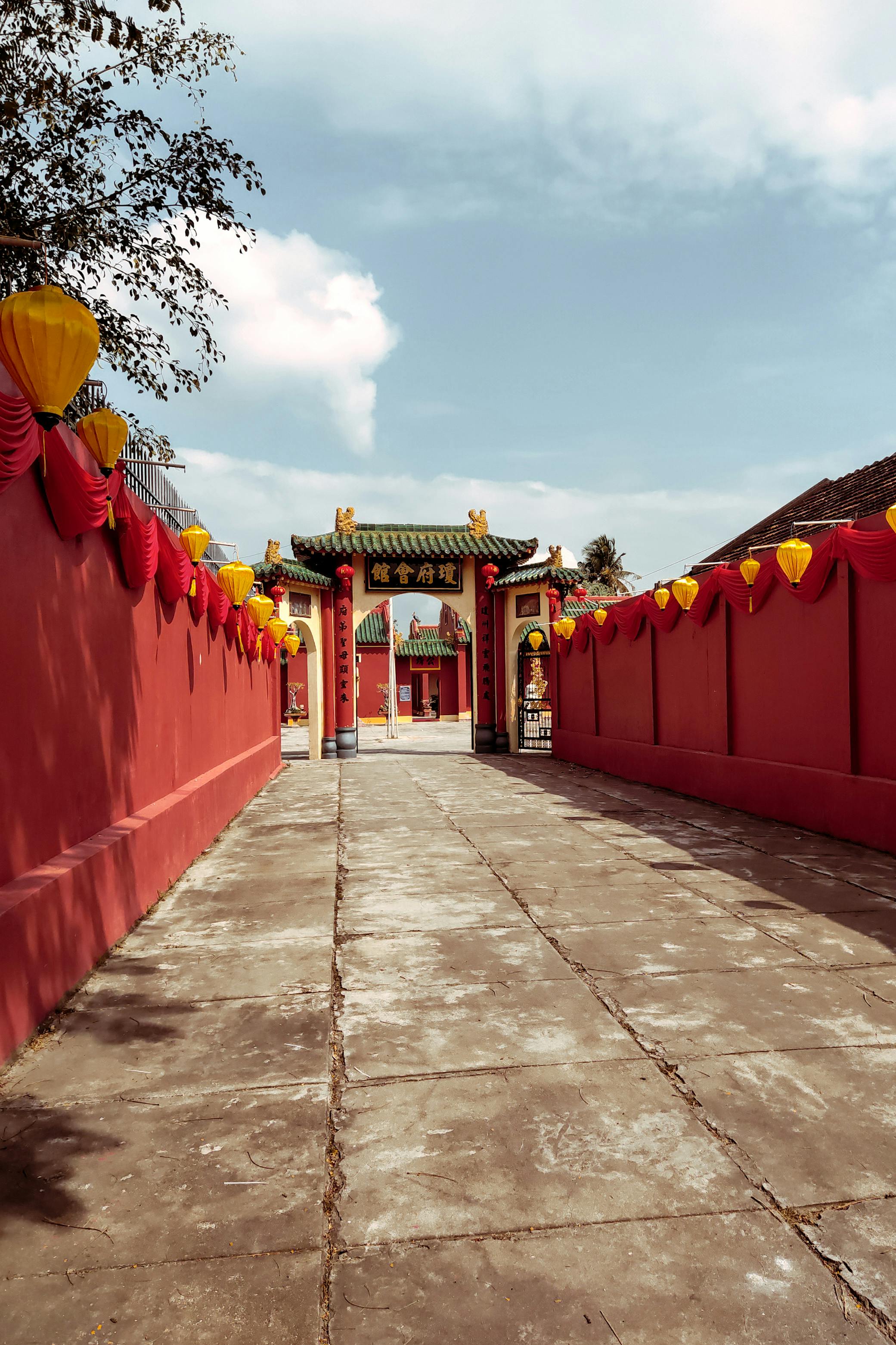 A red and yellow gate with red lanterns · Free Stock Photo