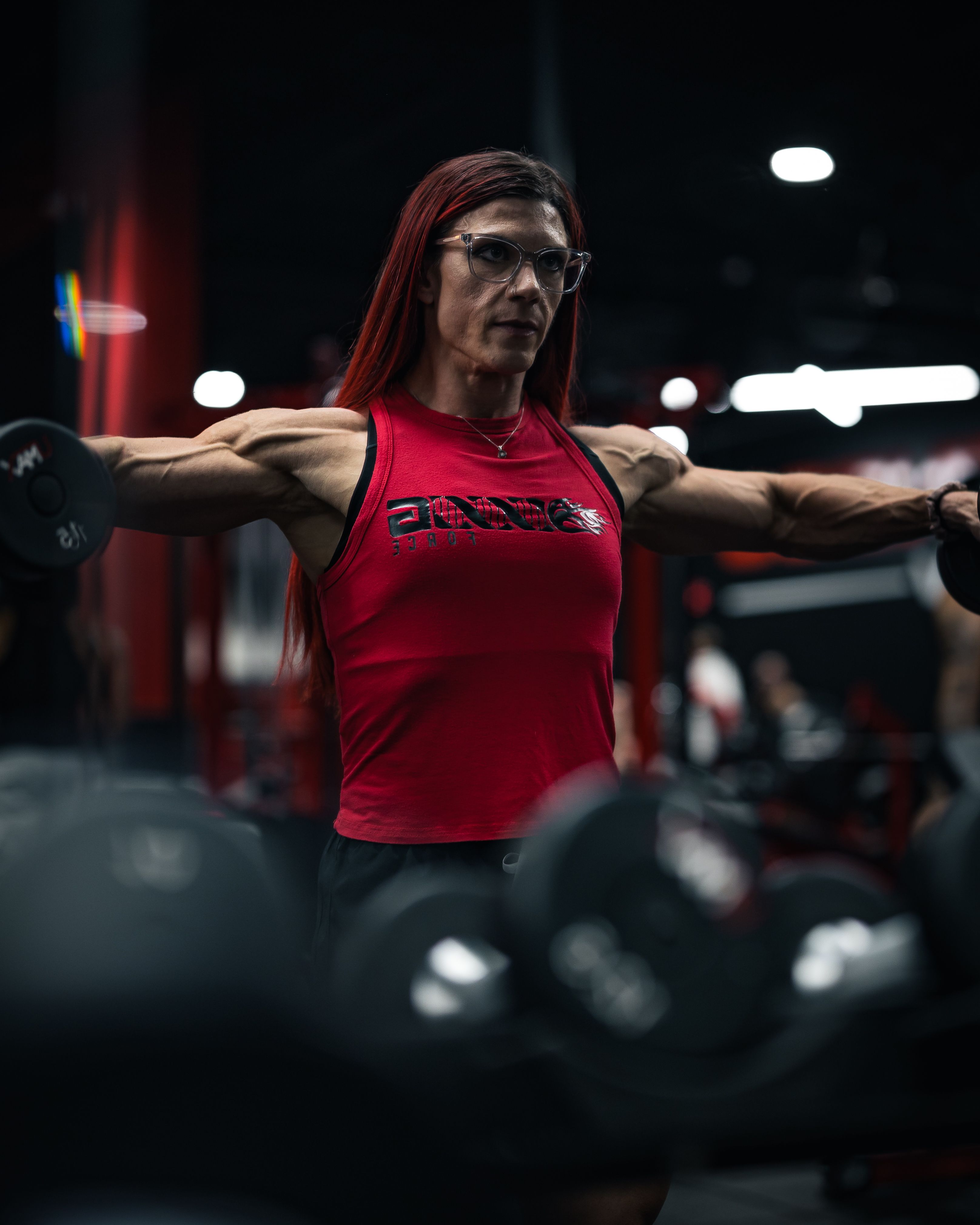 Woman in Red Tank Top Exercising at Gym · Free Stock Photo