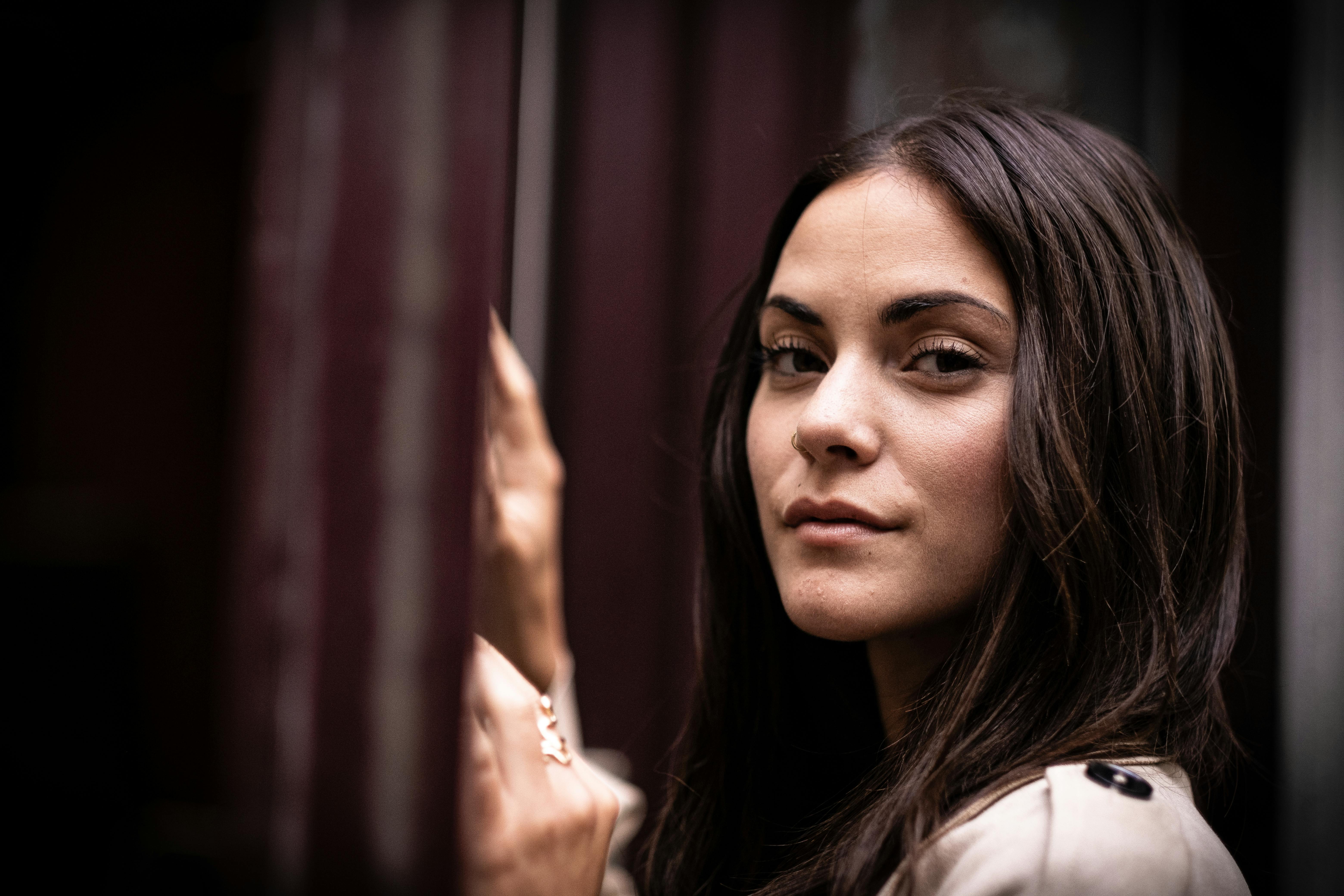 Portrait of a Woman Leaning Hands on a Wall · Free Stock Photo