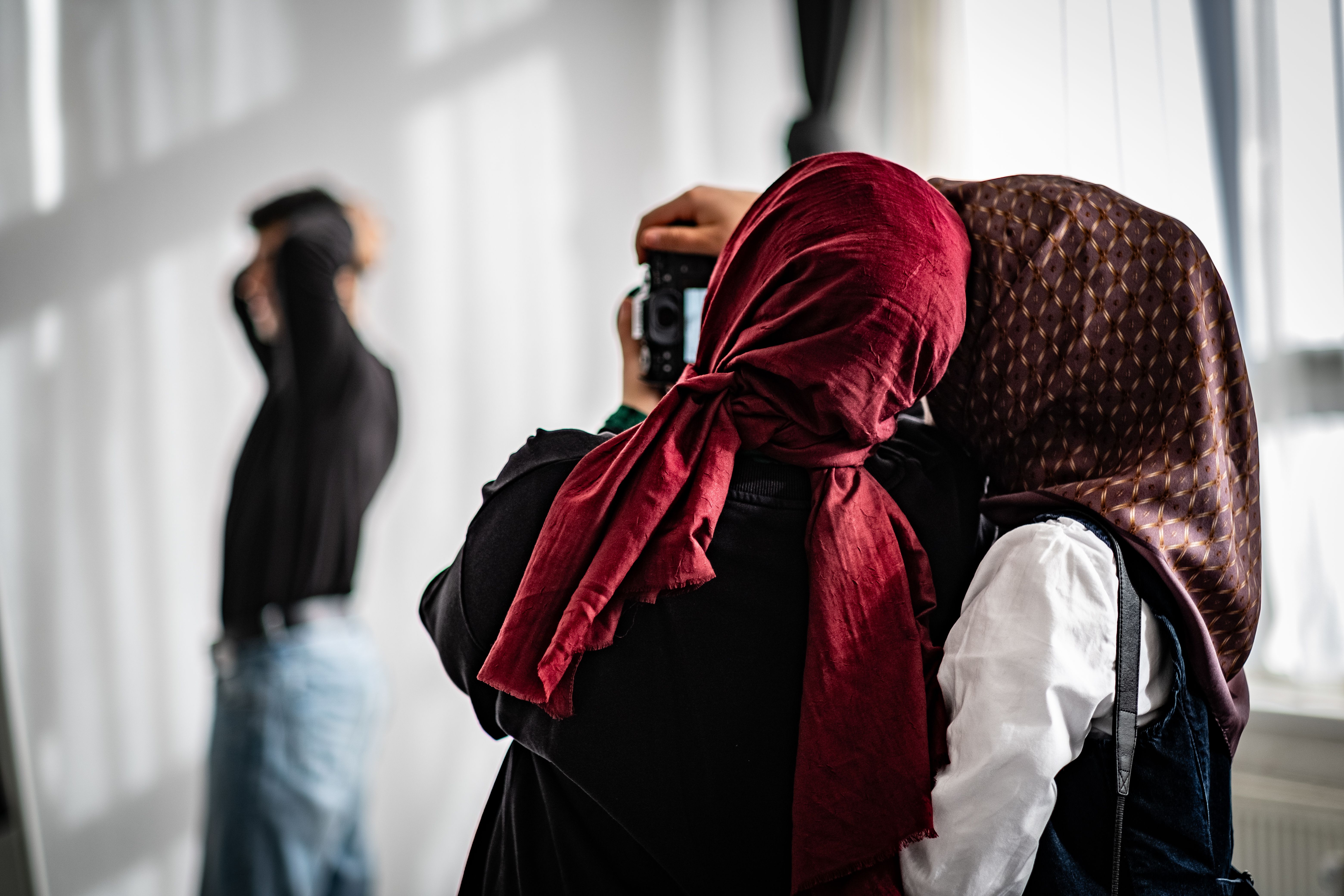 Back View of People in Headwear Taking a Picture · Free Stock Photo