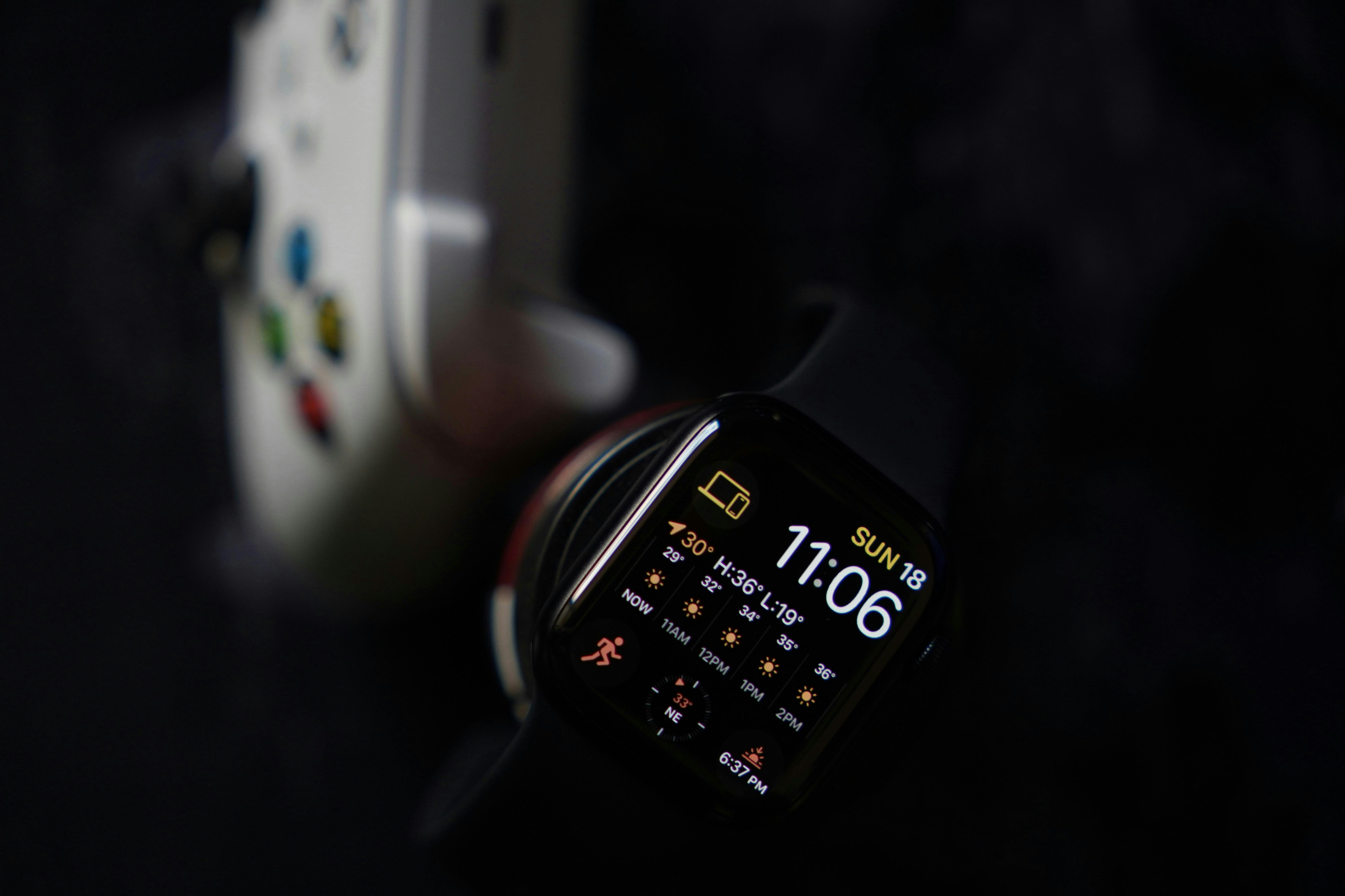 Closeup of a Smart Watch and a Game Controller · Free Stock Photo