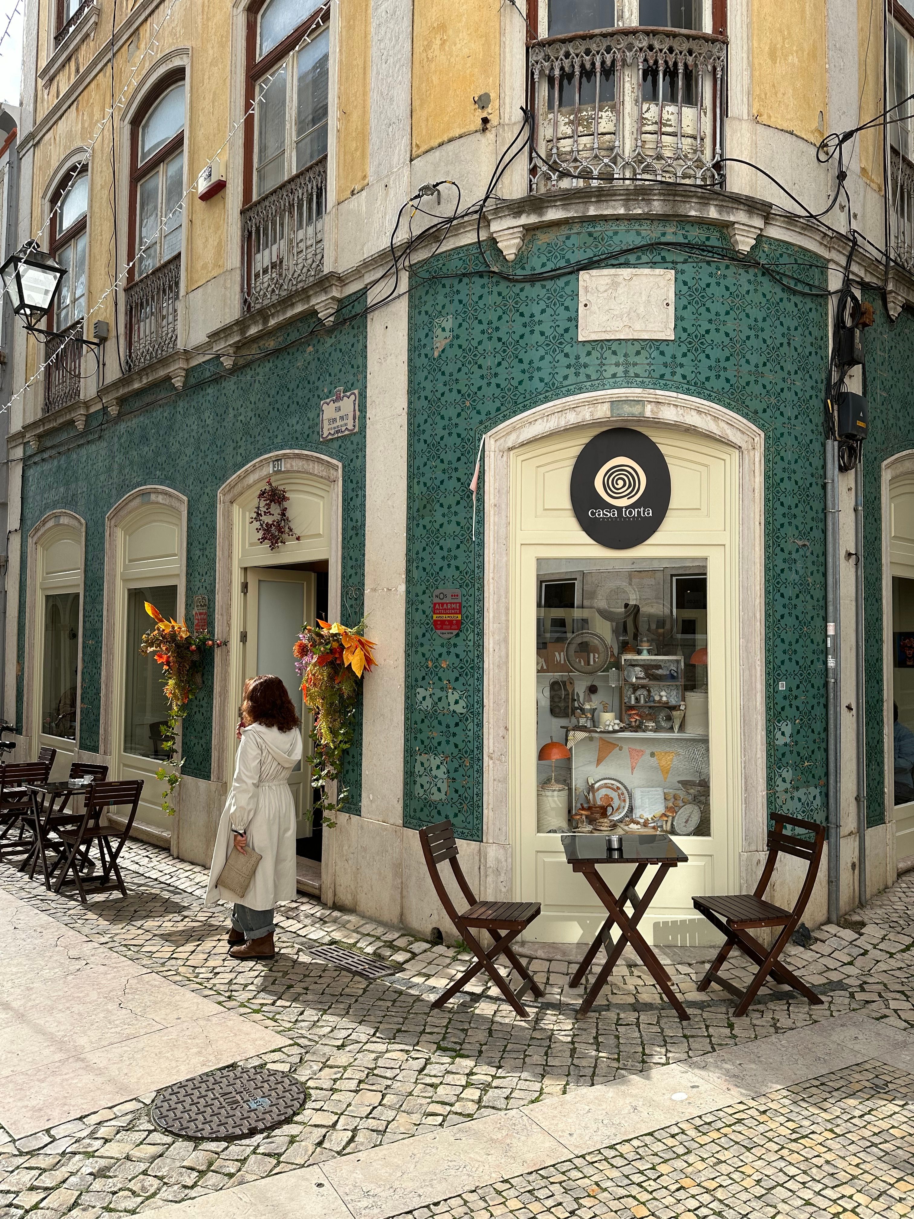 Front of a Cafe with Outdoor Tables on a Street · Free Stock Photo