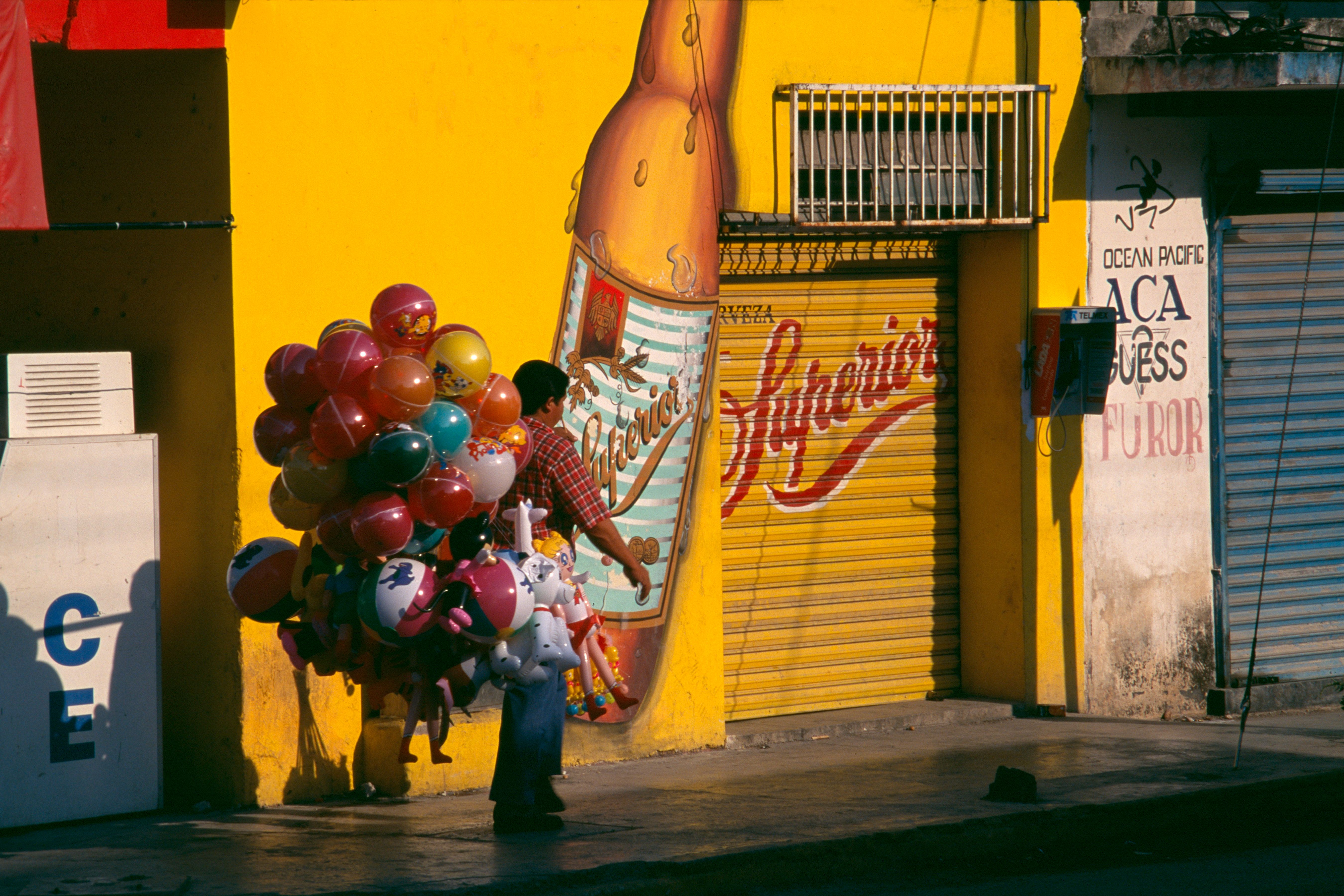 Man Walking with Colorful Balloons near Beer Mural on Wall · Free Stock ...