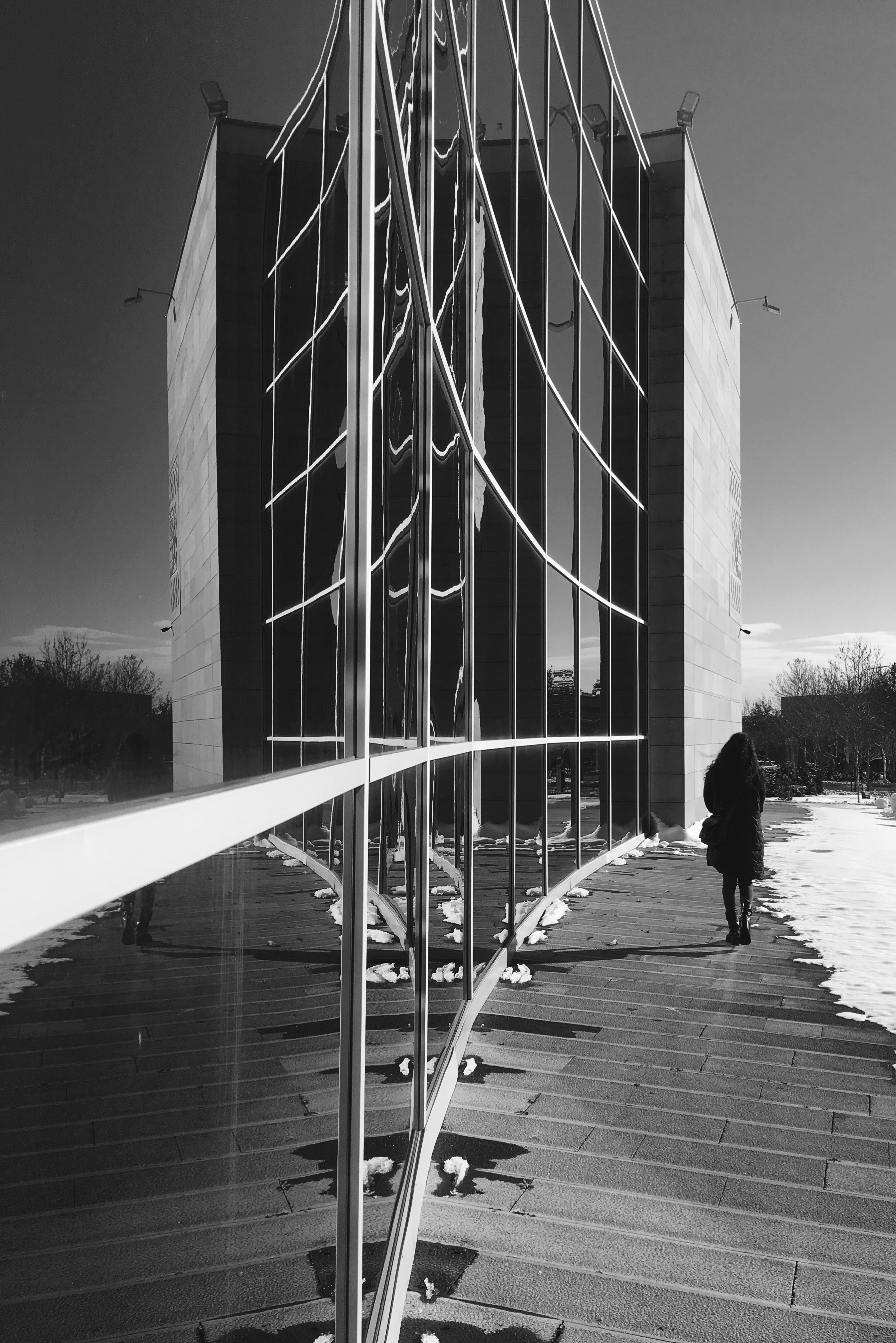 Person Walking next to a Glass Building Reflecting Itself · Free Stock ...