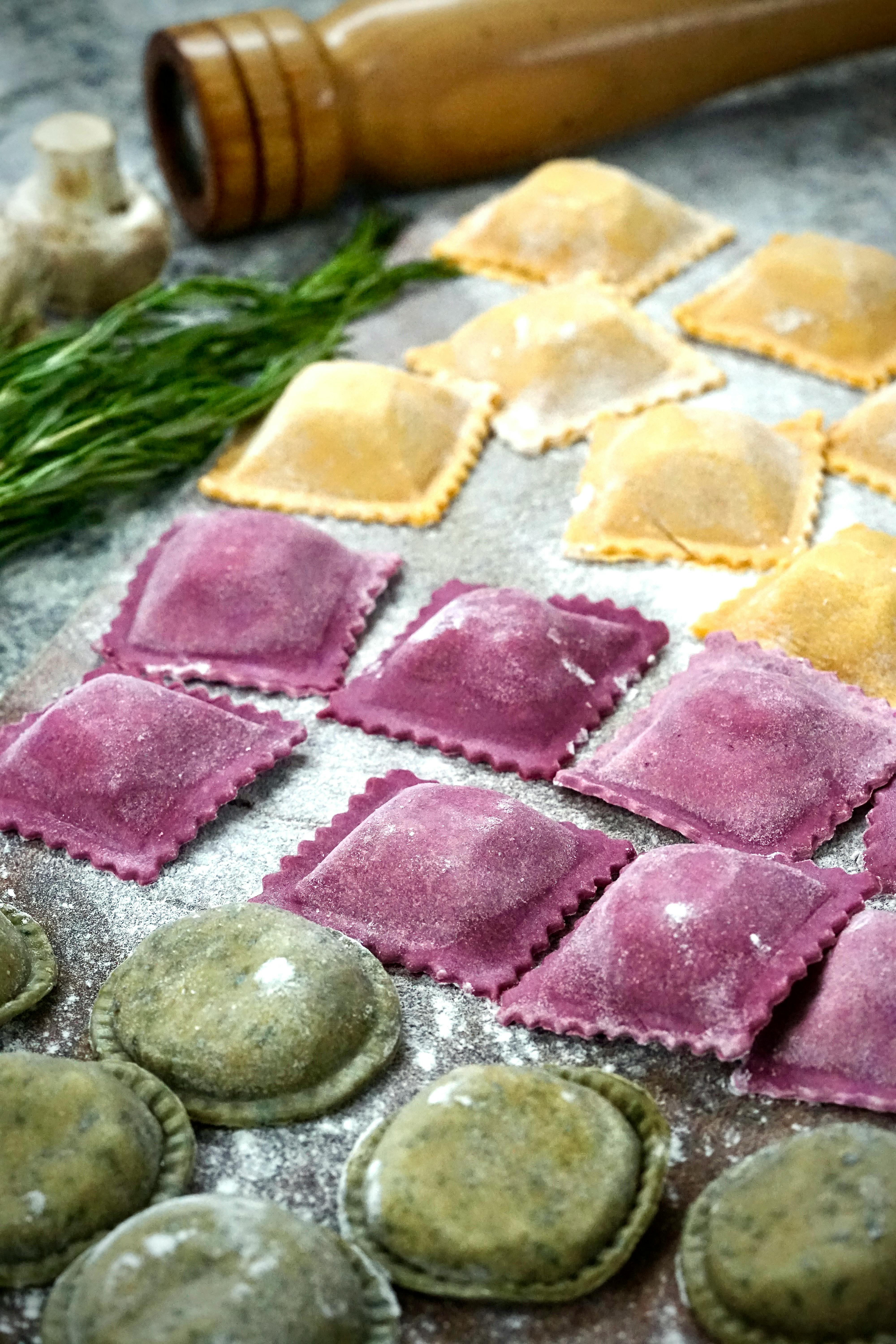 Close-up of Raw, Colorful Ravioli Lying on a Countertop · Free Stock Photo