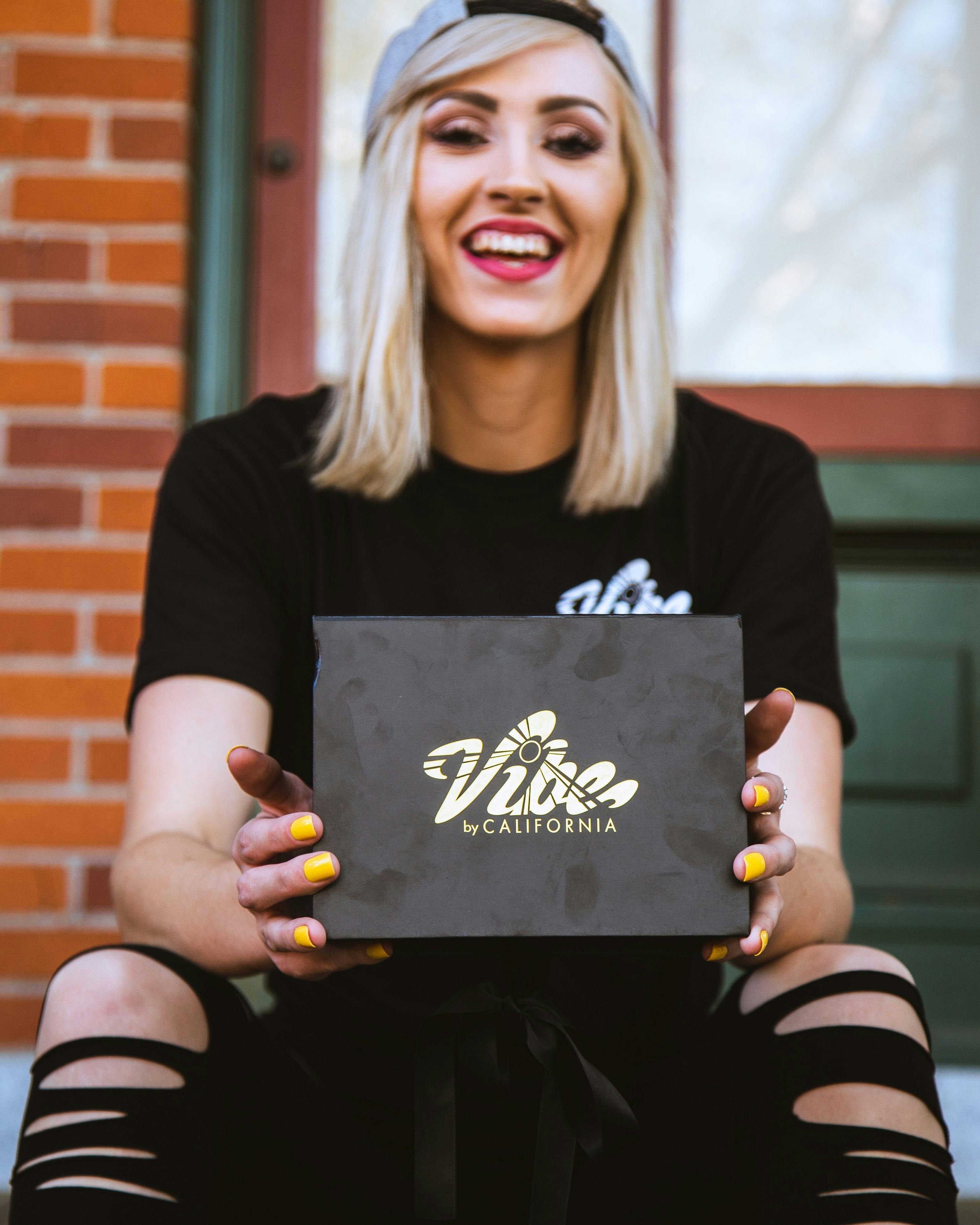 A Woman Holding a Box · Free Stock Photo