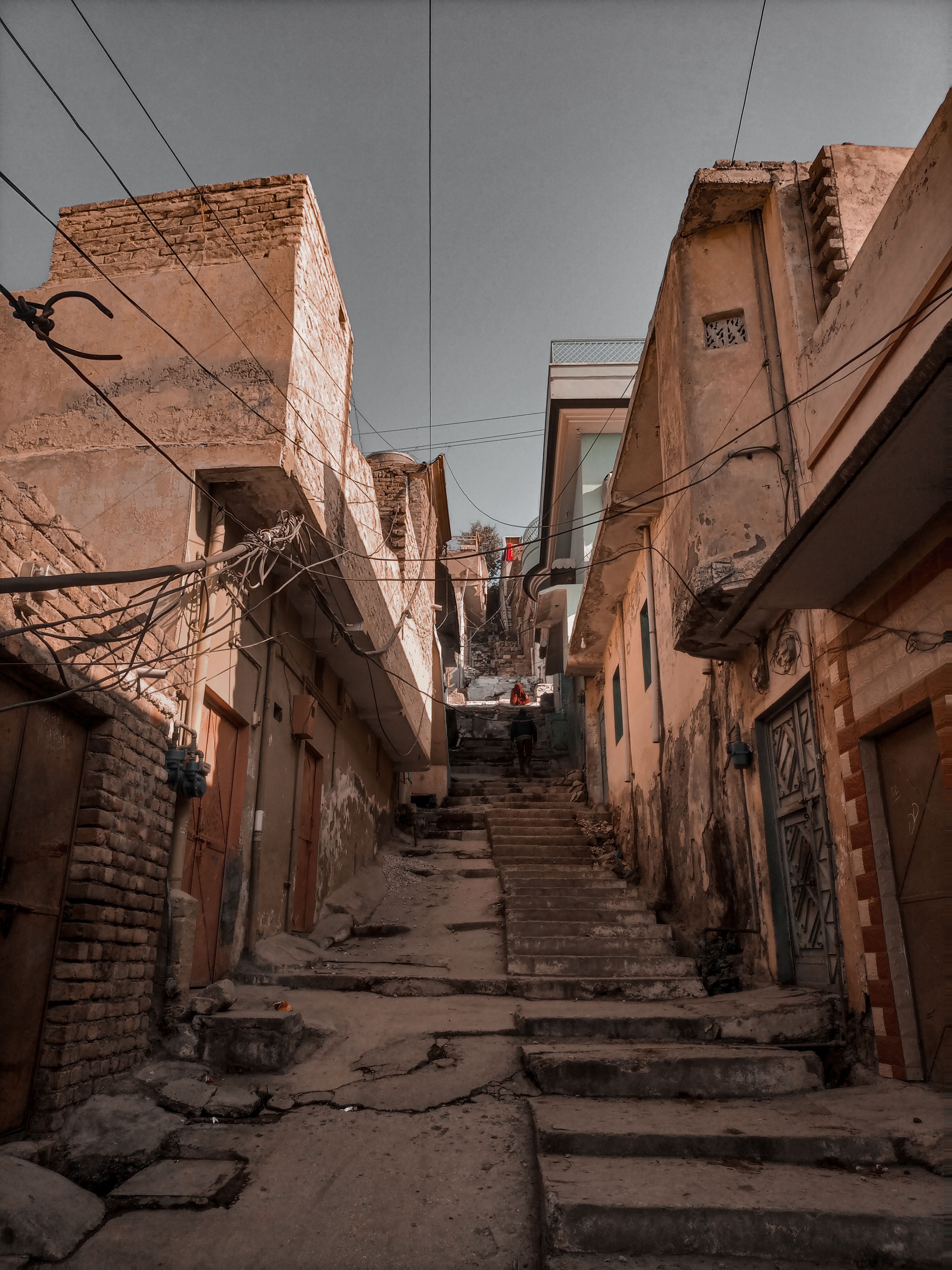 A narrow alley with stairs leading up to a building · Free Stock Photo