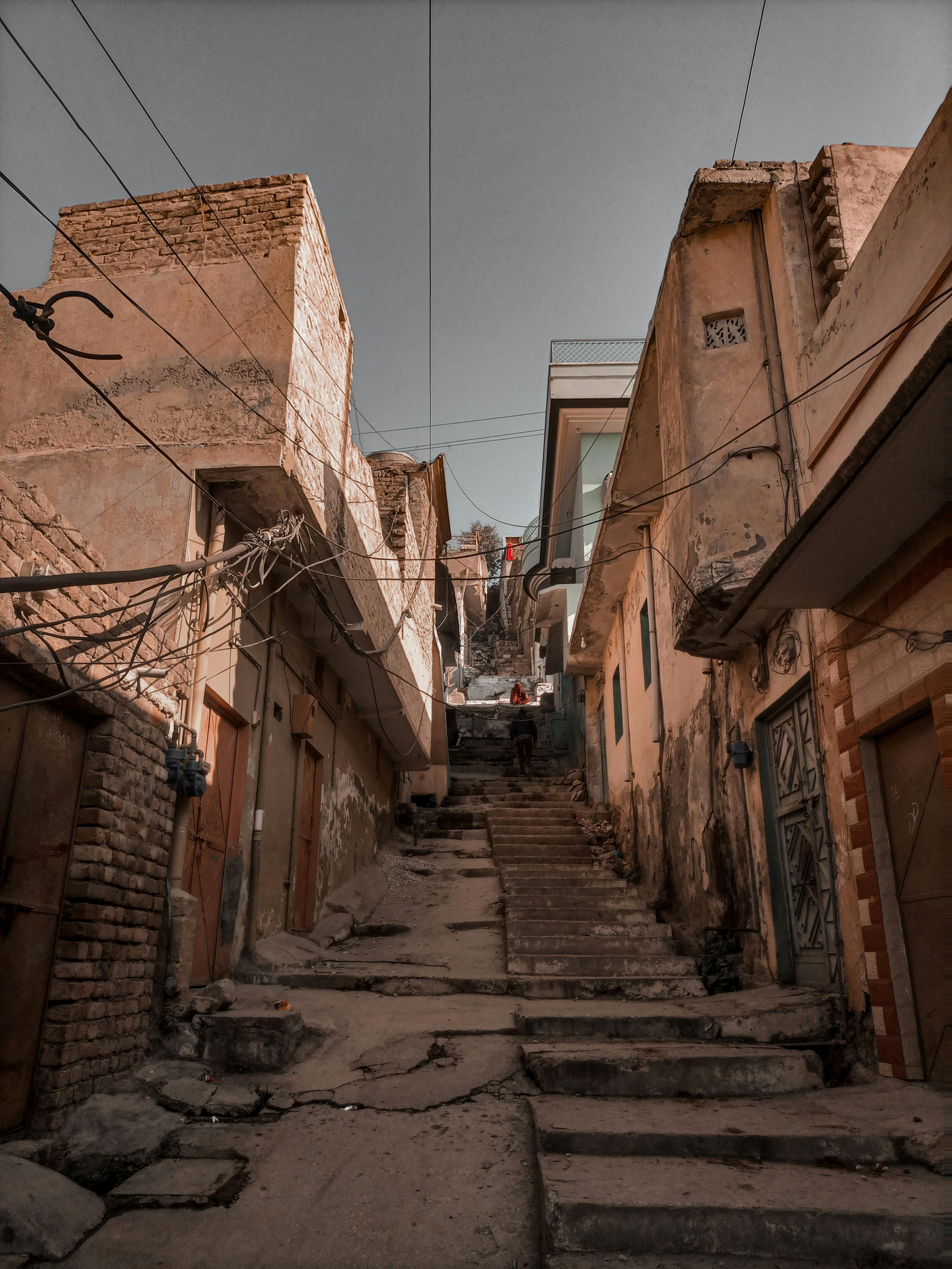 Narrow pathway between blue buildings · Free Stock Photo