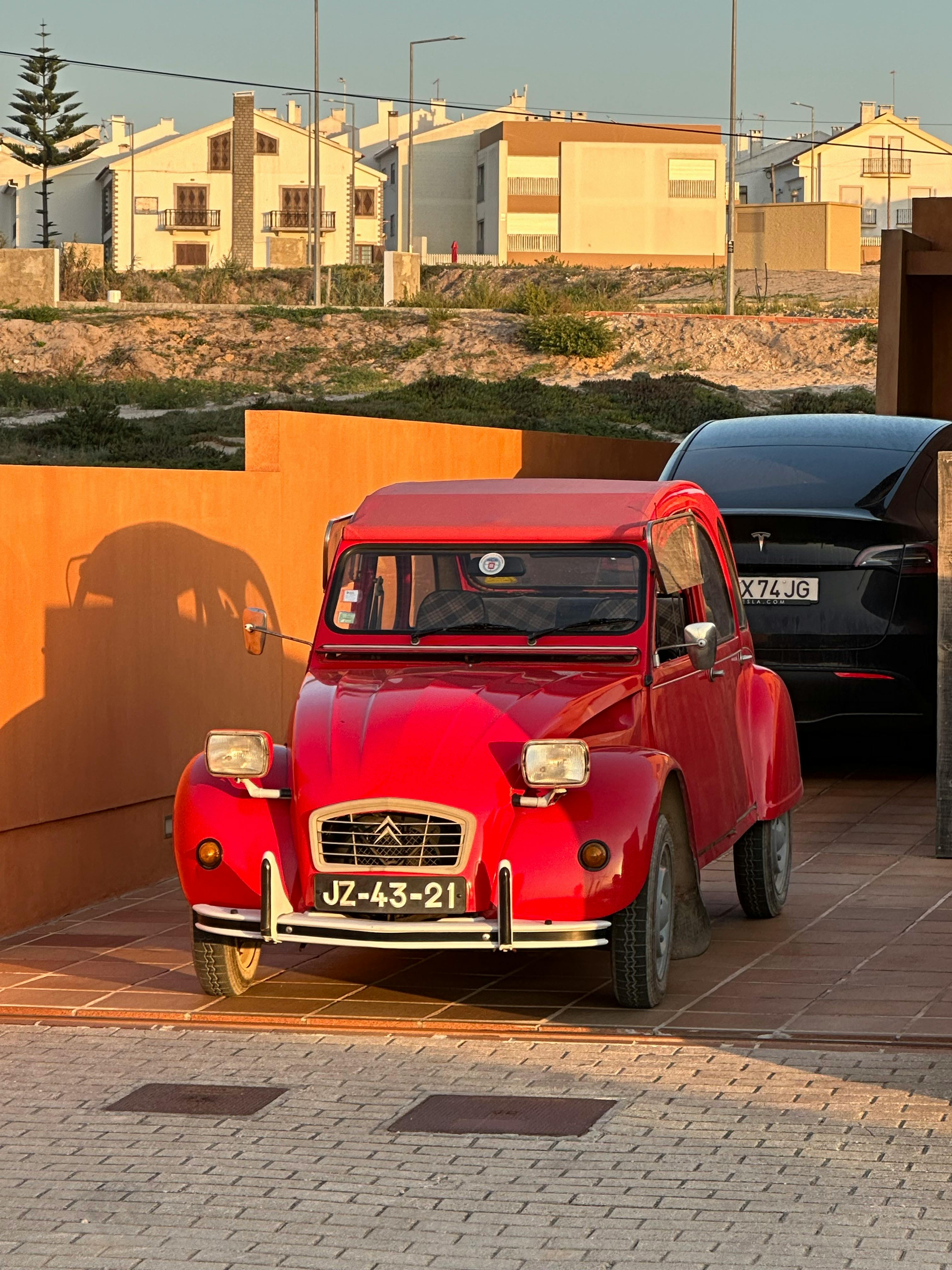 Classic Red Citroen 2CV Parked in the Driveway by a Tesla · Free Stock ...