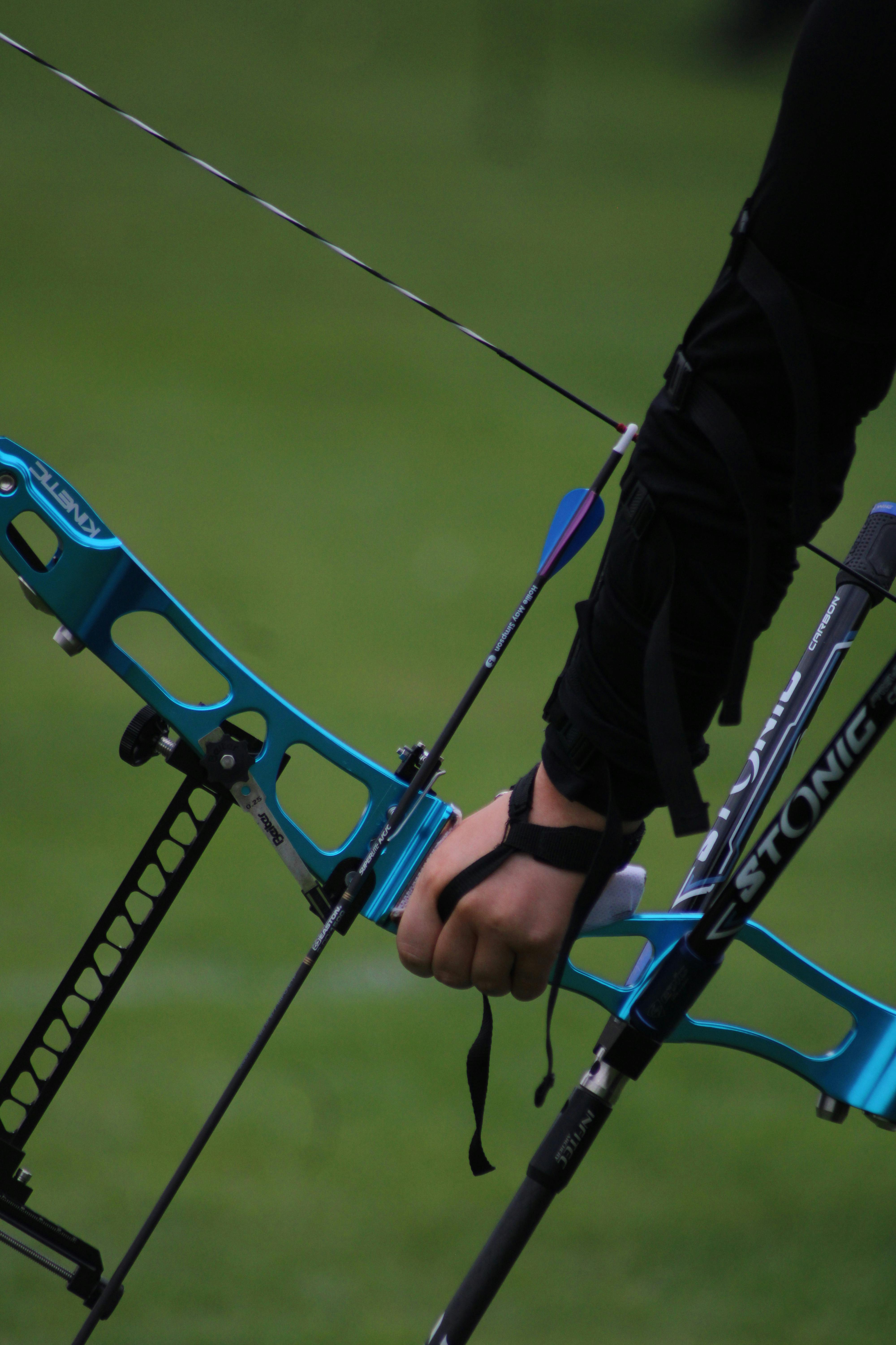 An Archer Pulling and Aiming a Compound Bow · Free Stock Photo