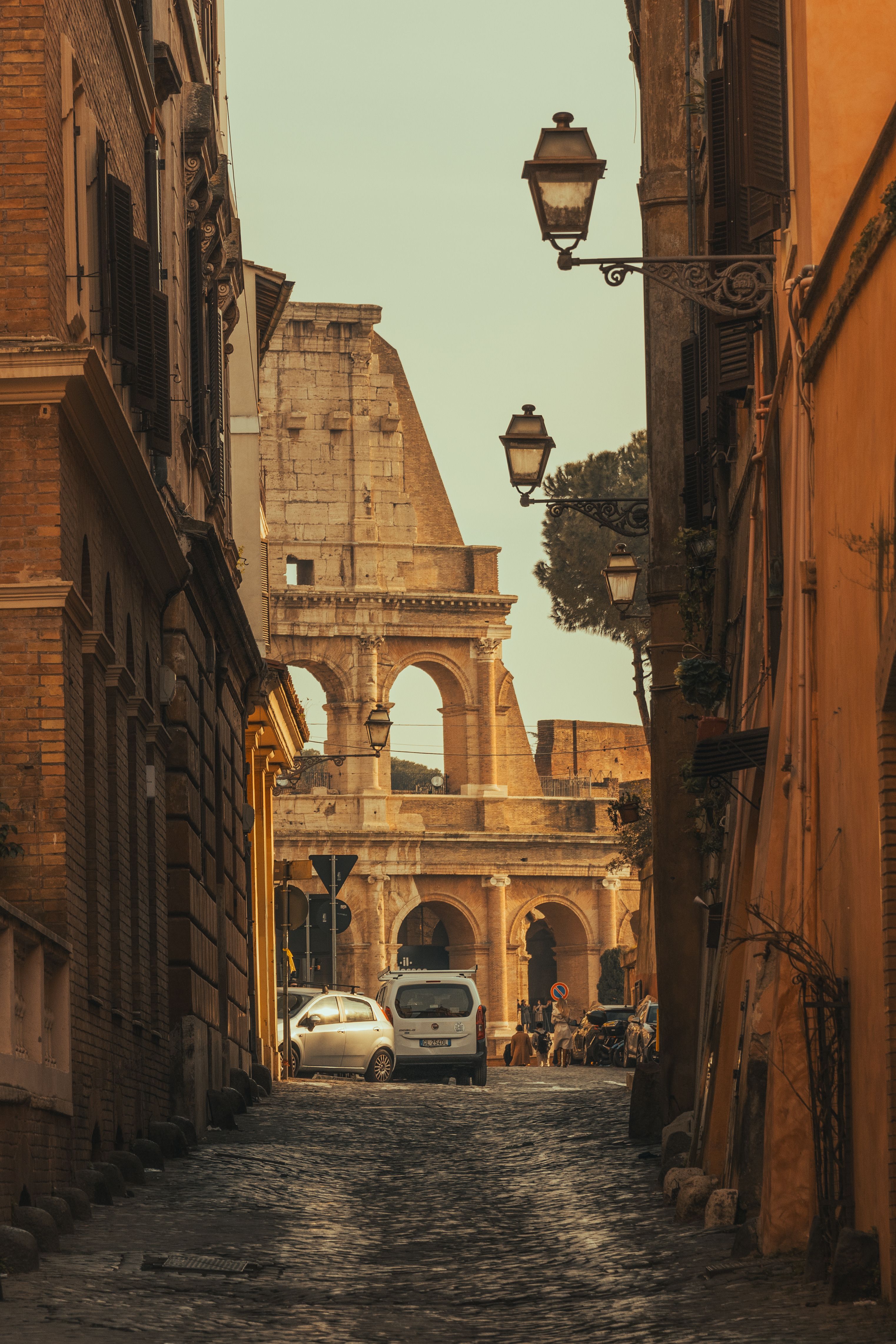 A street in rome with a car driving down it · Free Stock Photo