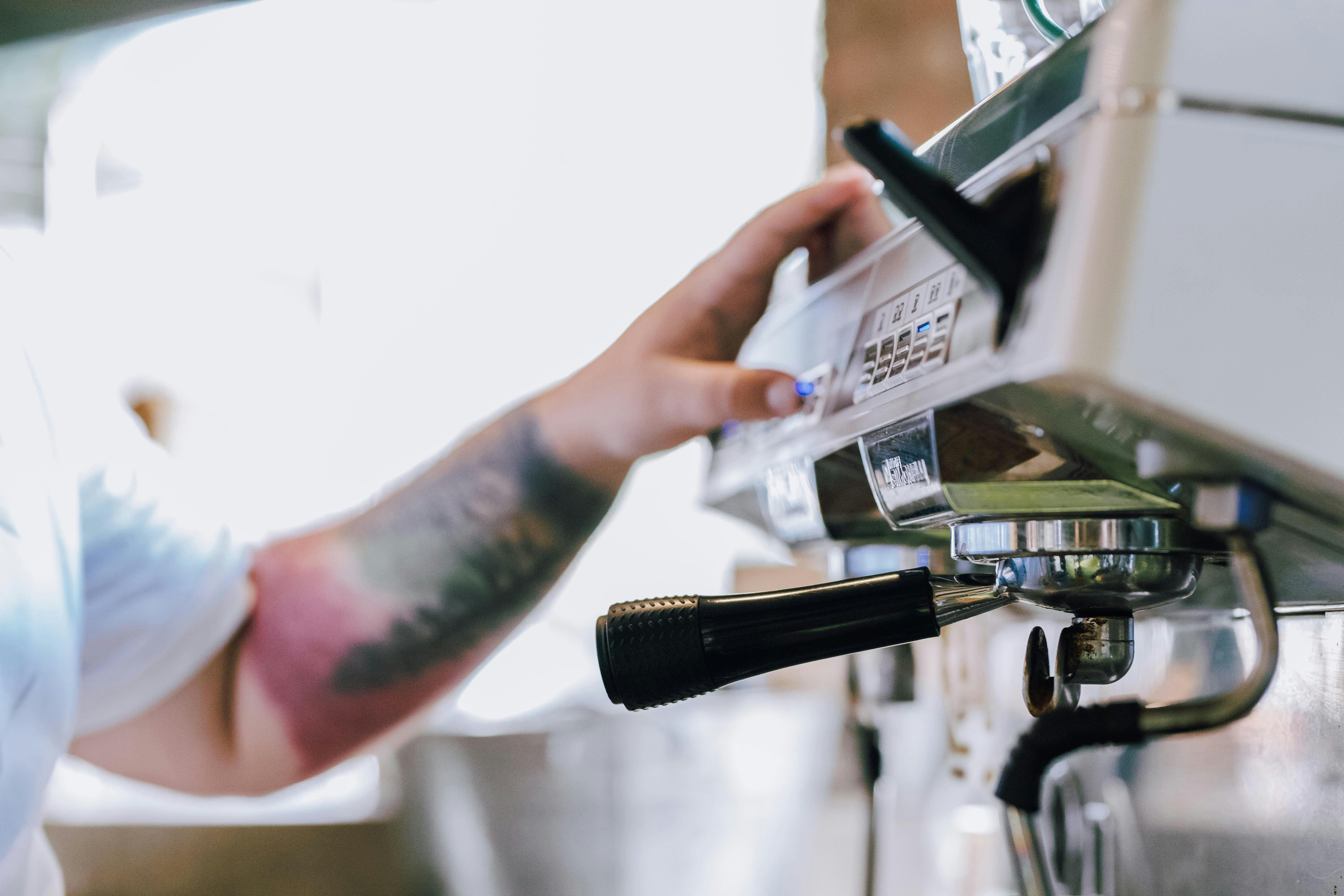 Person Arm Using Coffee Machine · Free Stock Photo