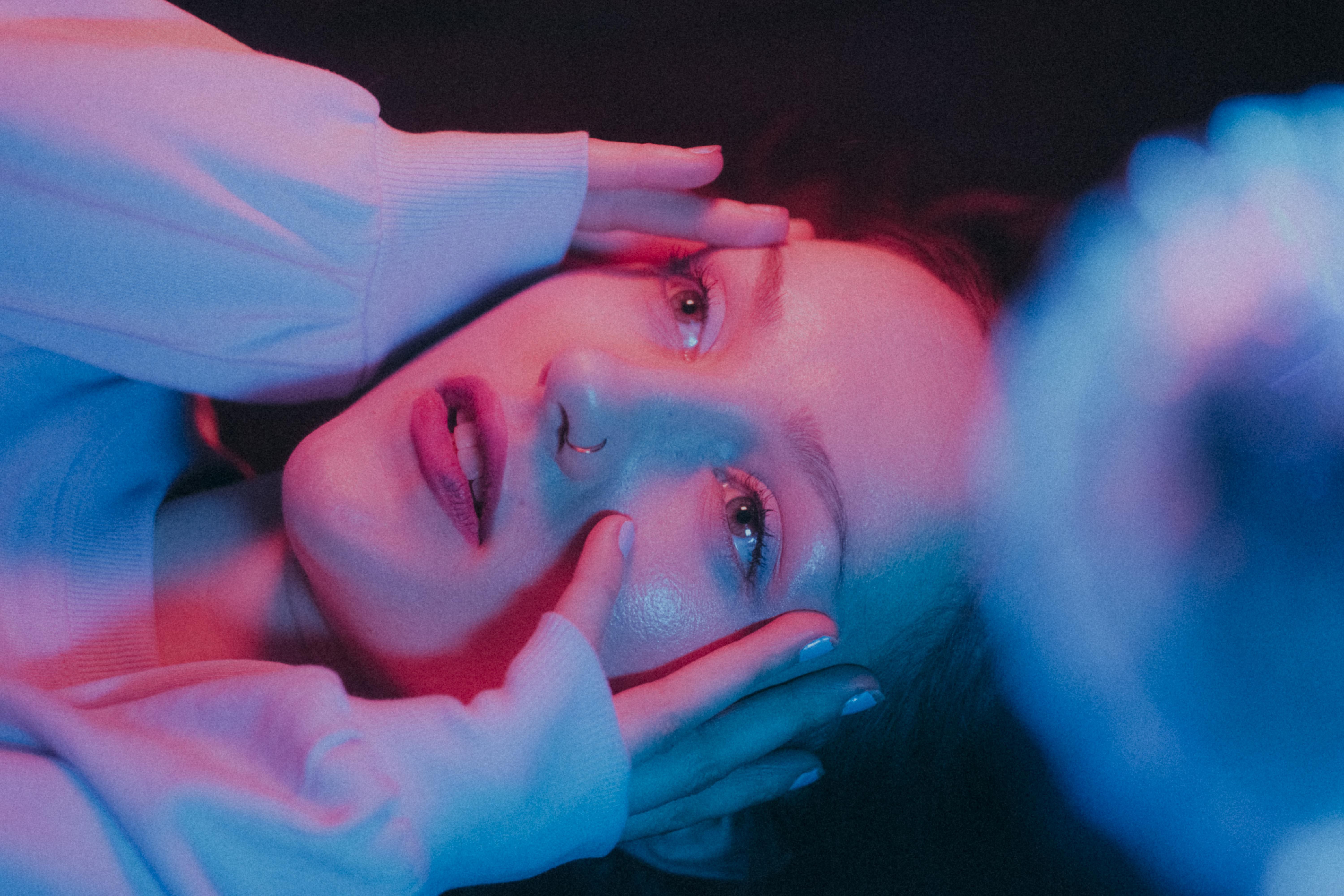 Photo of a Young Woman in Split Lighting · Free Stock Photo