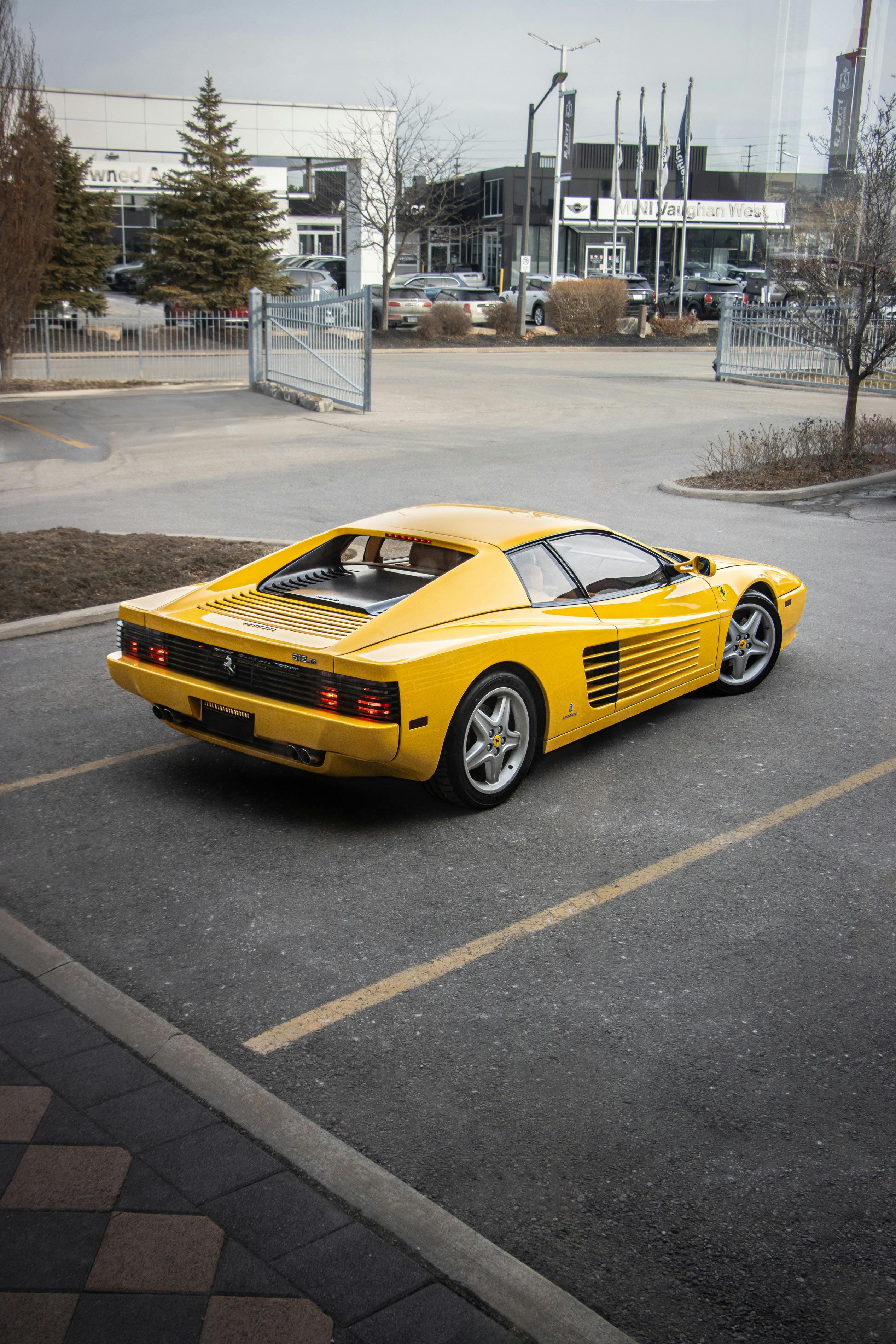 A Yellow Ferrari 512 TR on a Parking Lot · Free Stock Photo