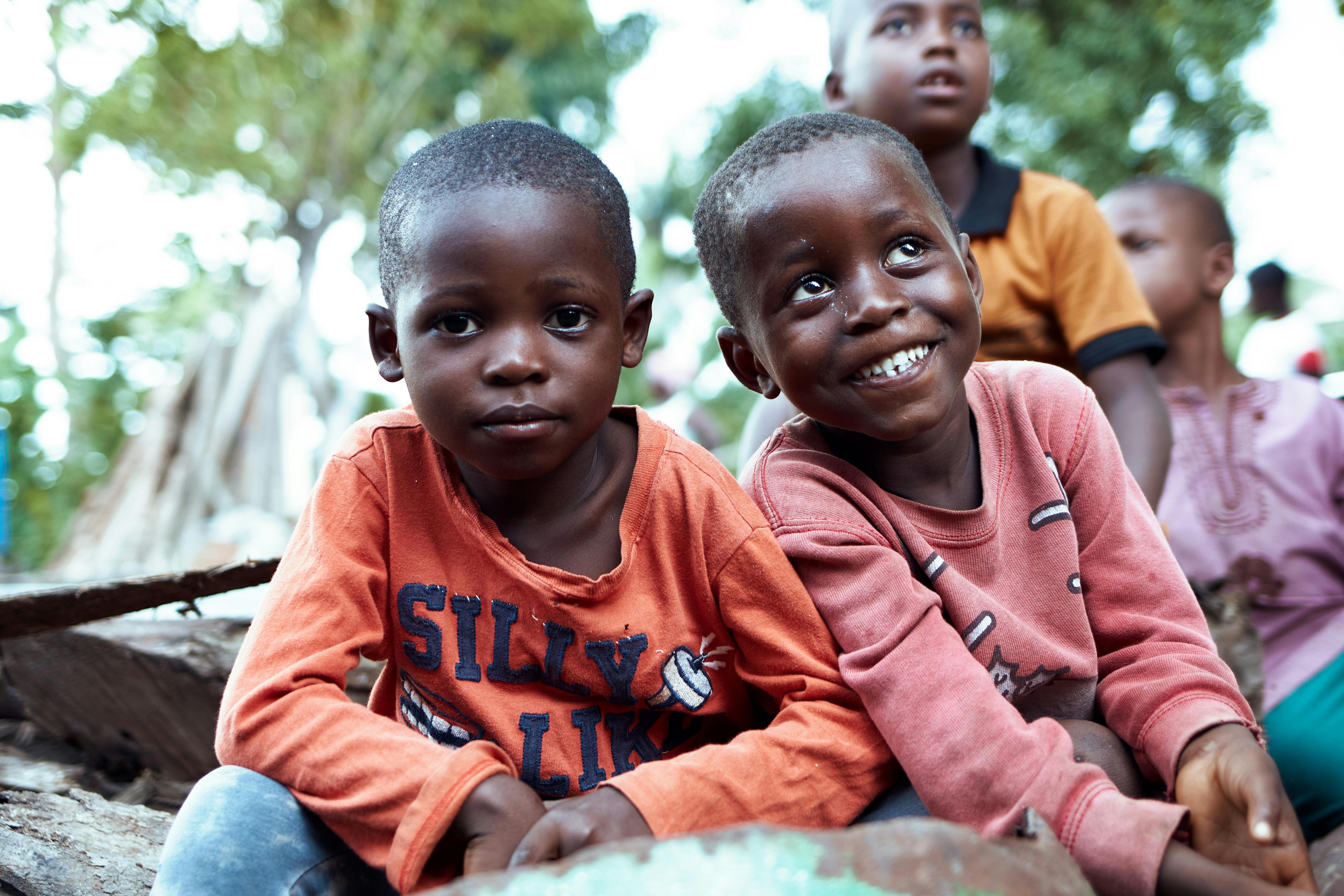 Photo of a Group of Kids Sitting Outside · Free Stock Photo
