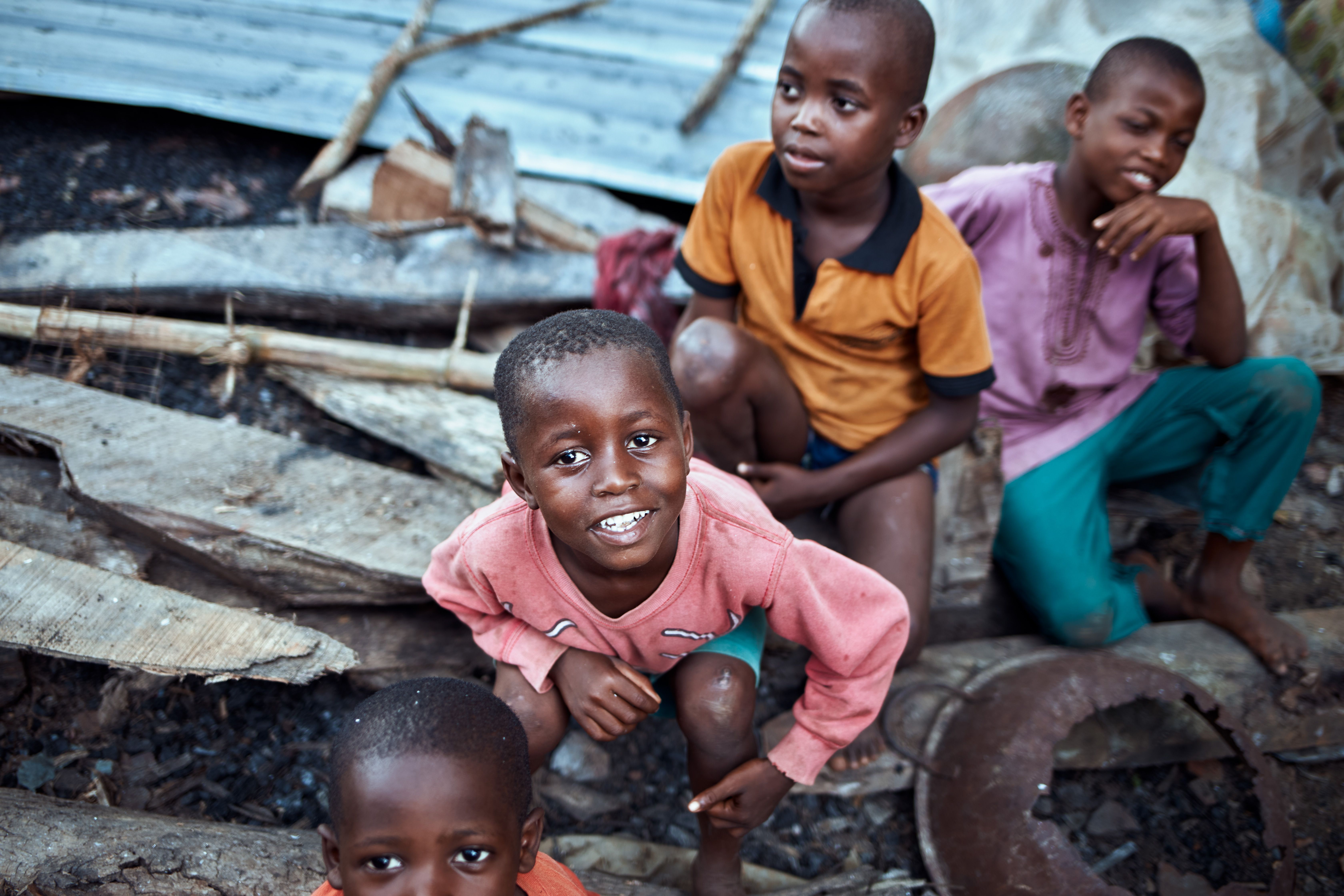 Group of Children Among Tree Logs · Free Stock Photo