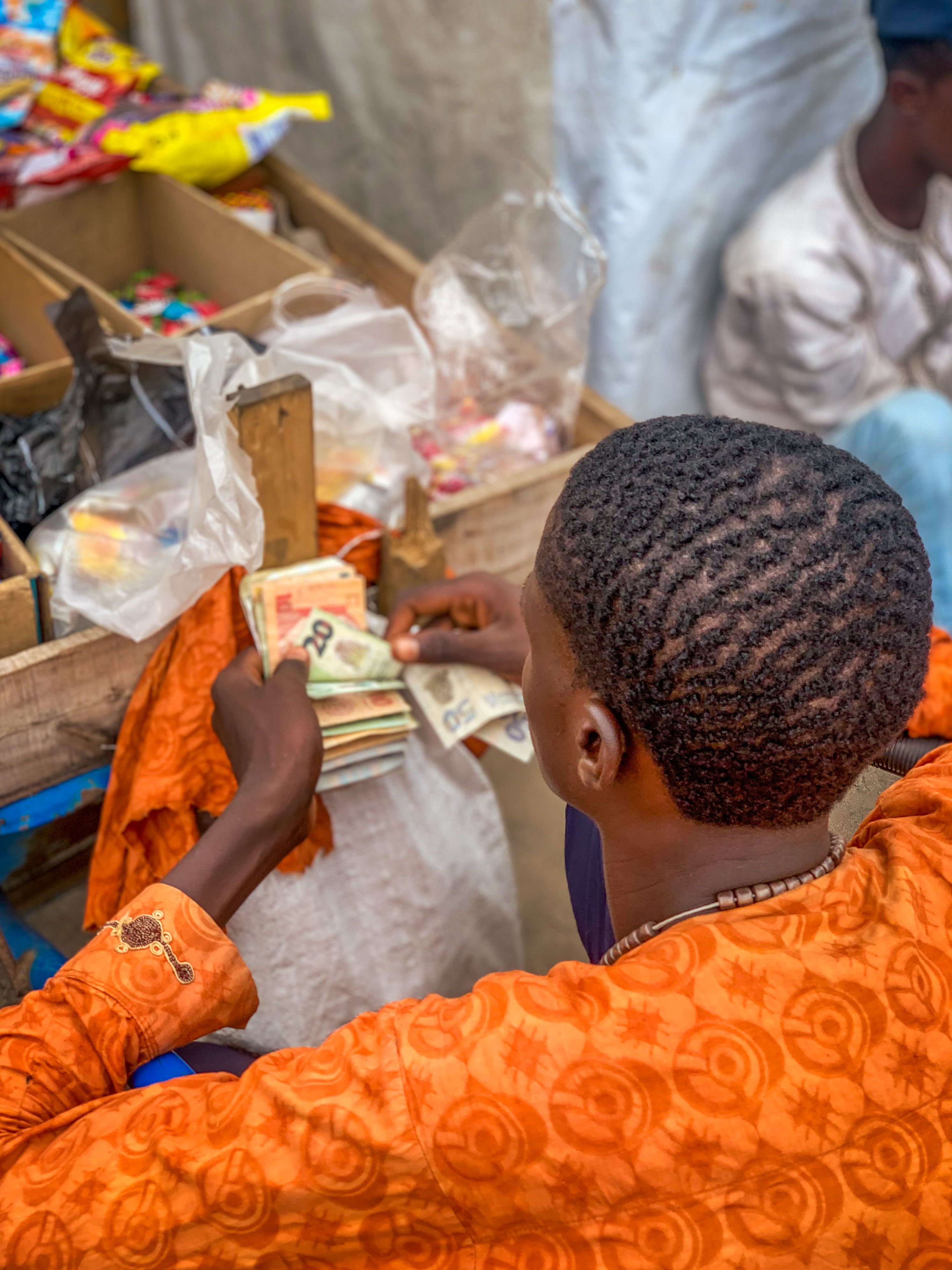 A young boy is selling some money · Free Stock Photo
