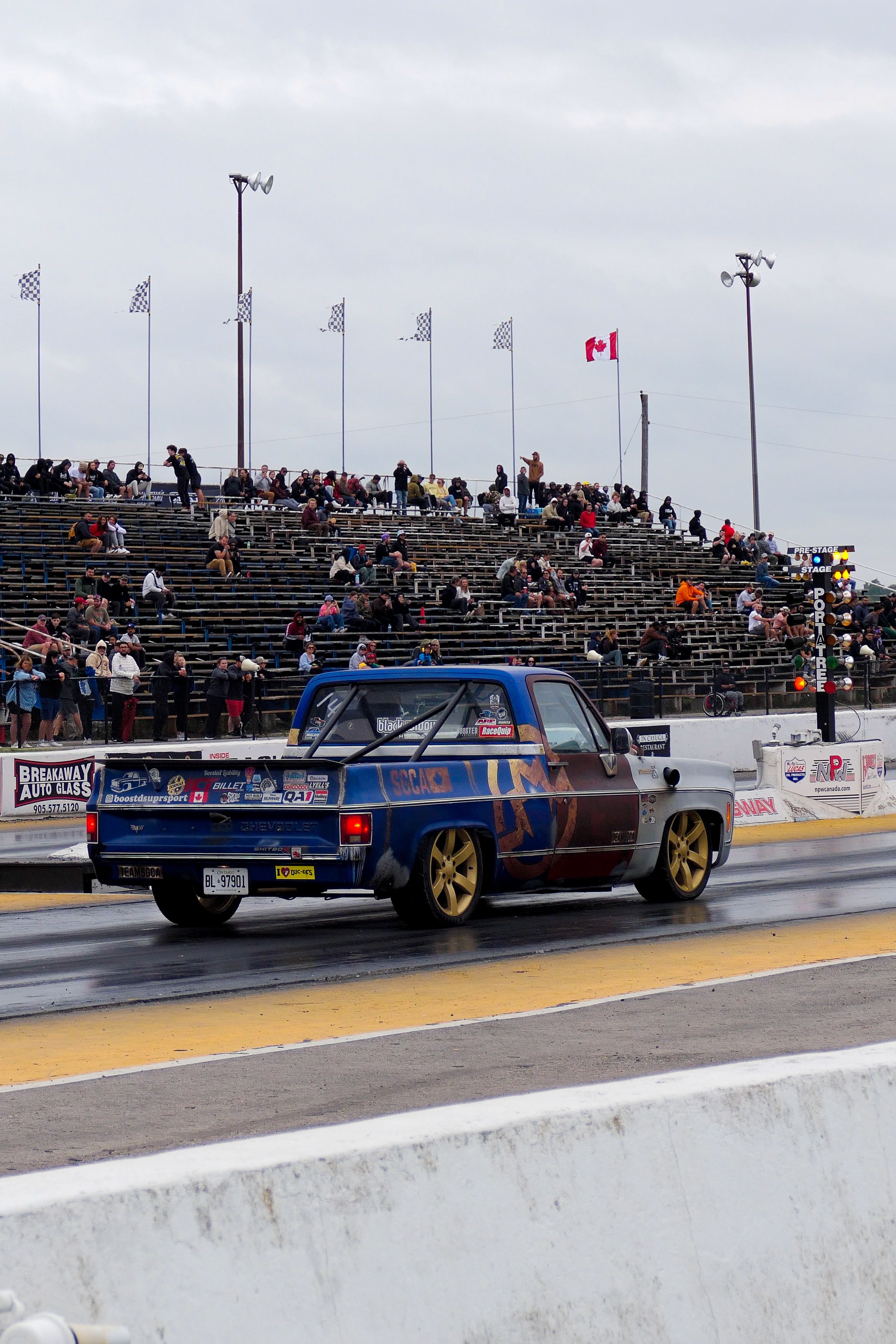 A Classic Modified Truck on a Race Truck with People Watching from the ...