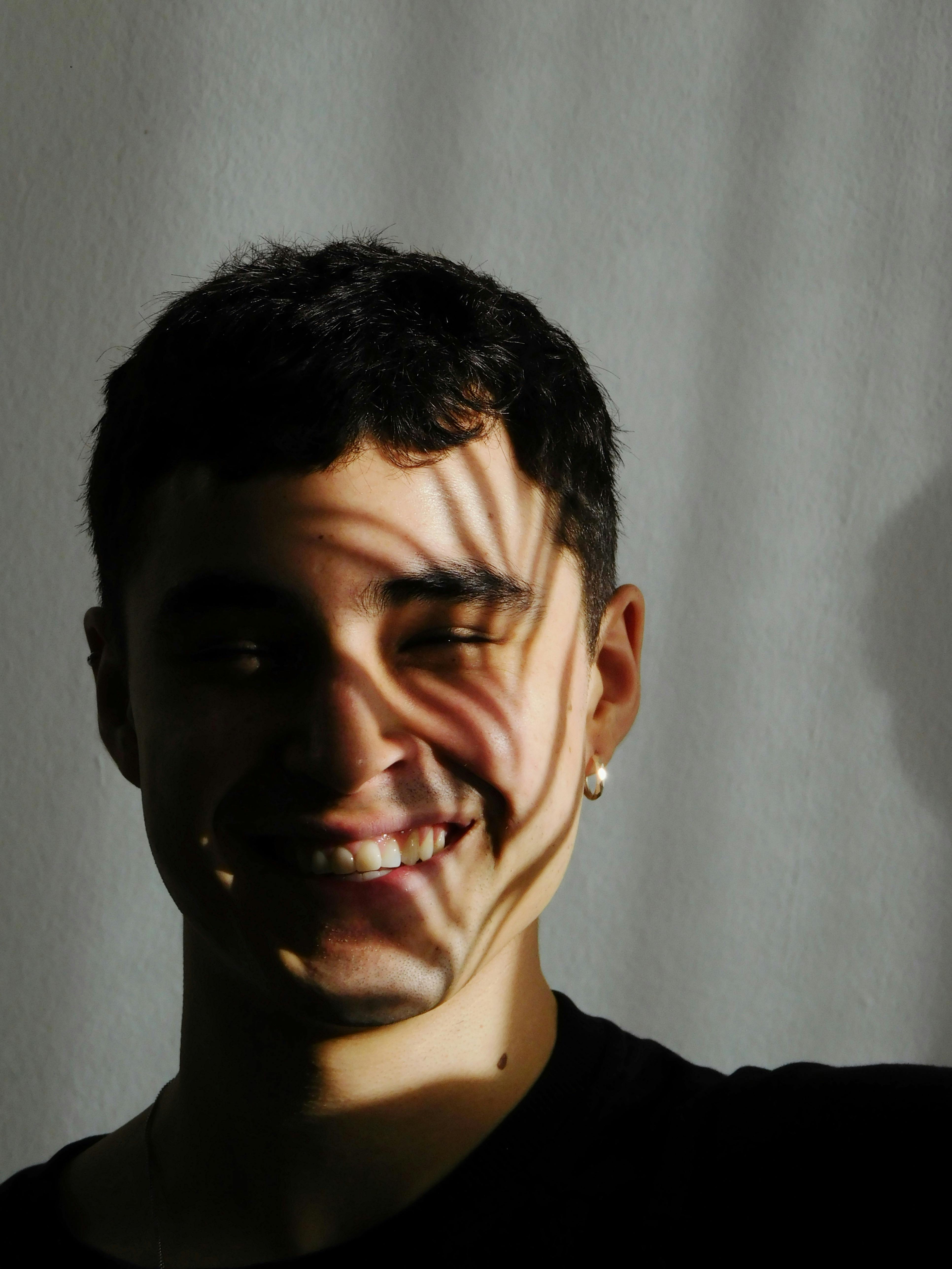 Shadows on Smiling Man Face · Free Stock Photo