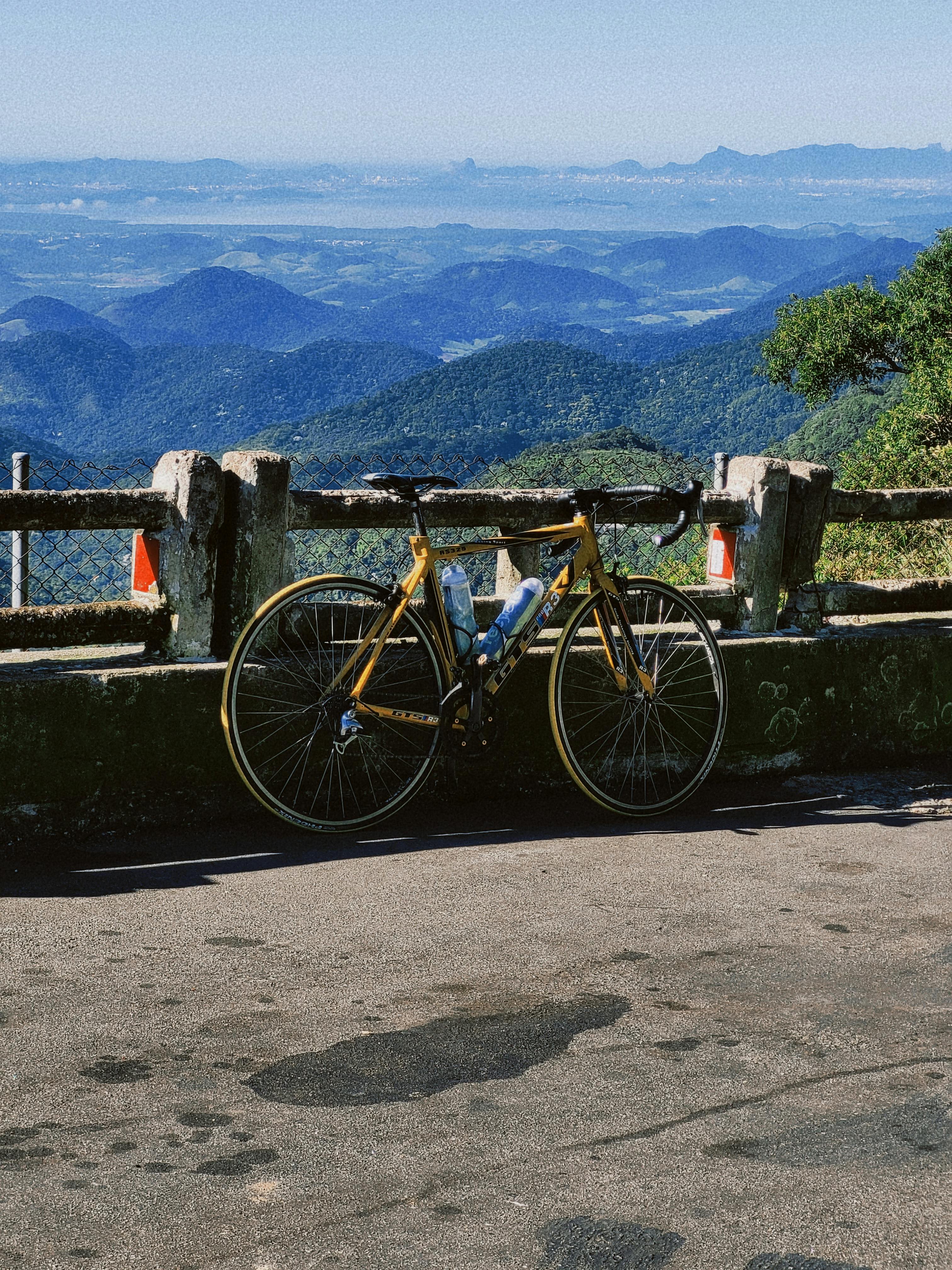 Racing Bike Leaning on Road Railing · Free Stock Photo