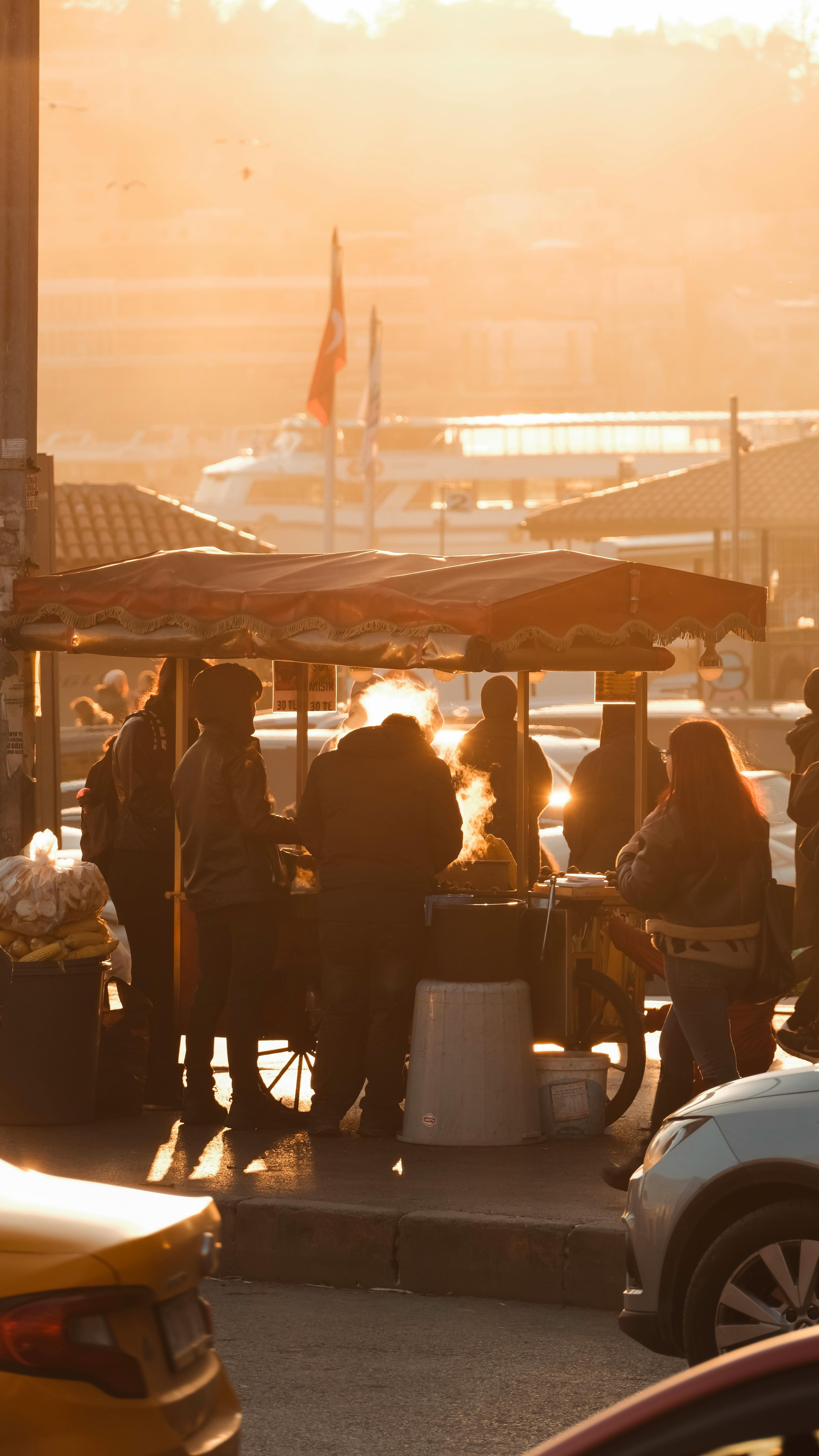 View of Cars on a Street and Pedestrians at Market Stalls on a Sidewalk ...