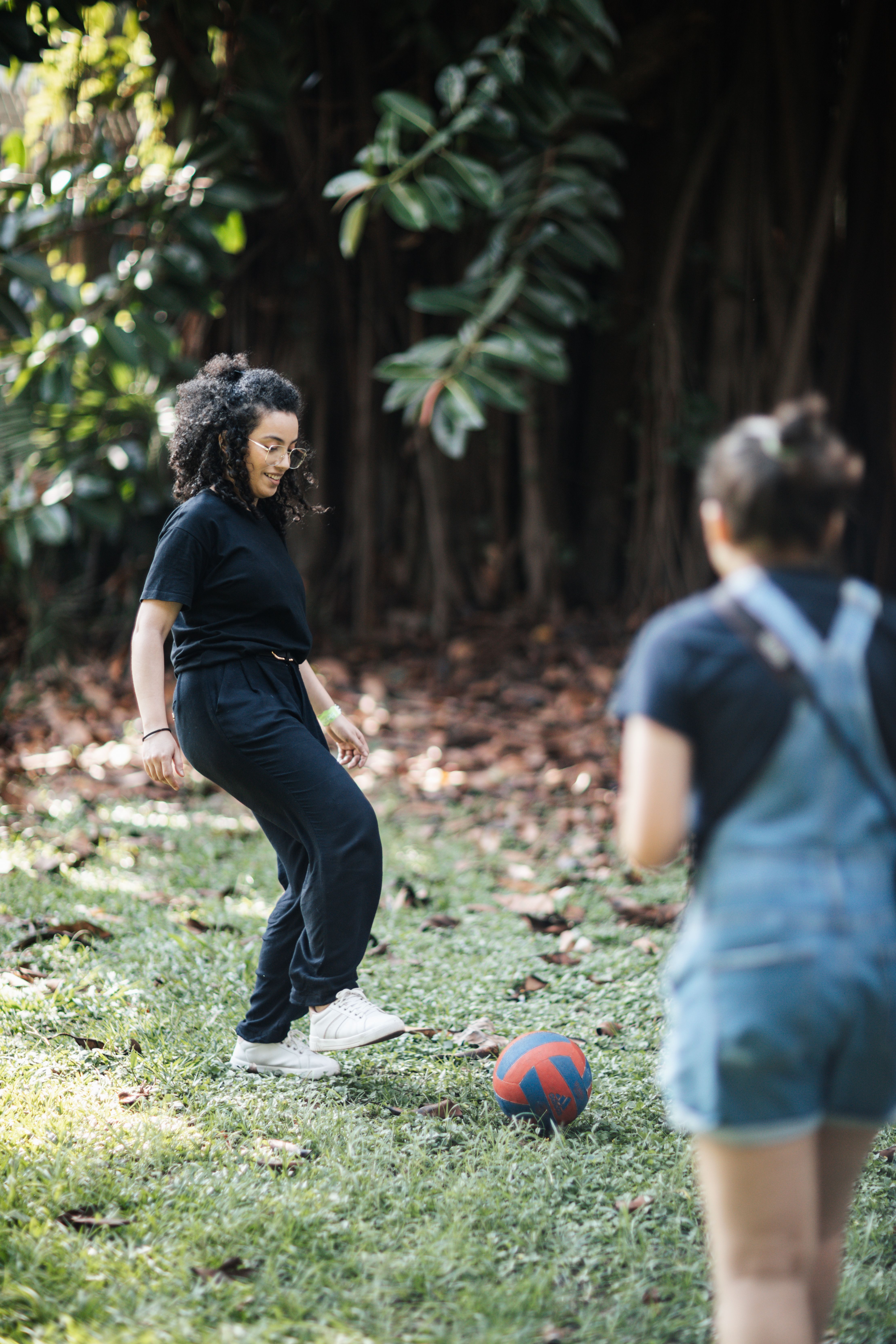 Brunette Woman Kicking Ball · Free Stock Photo