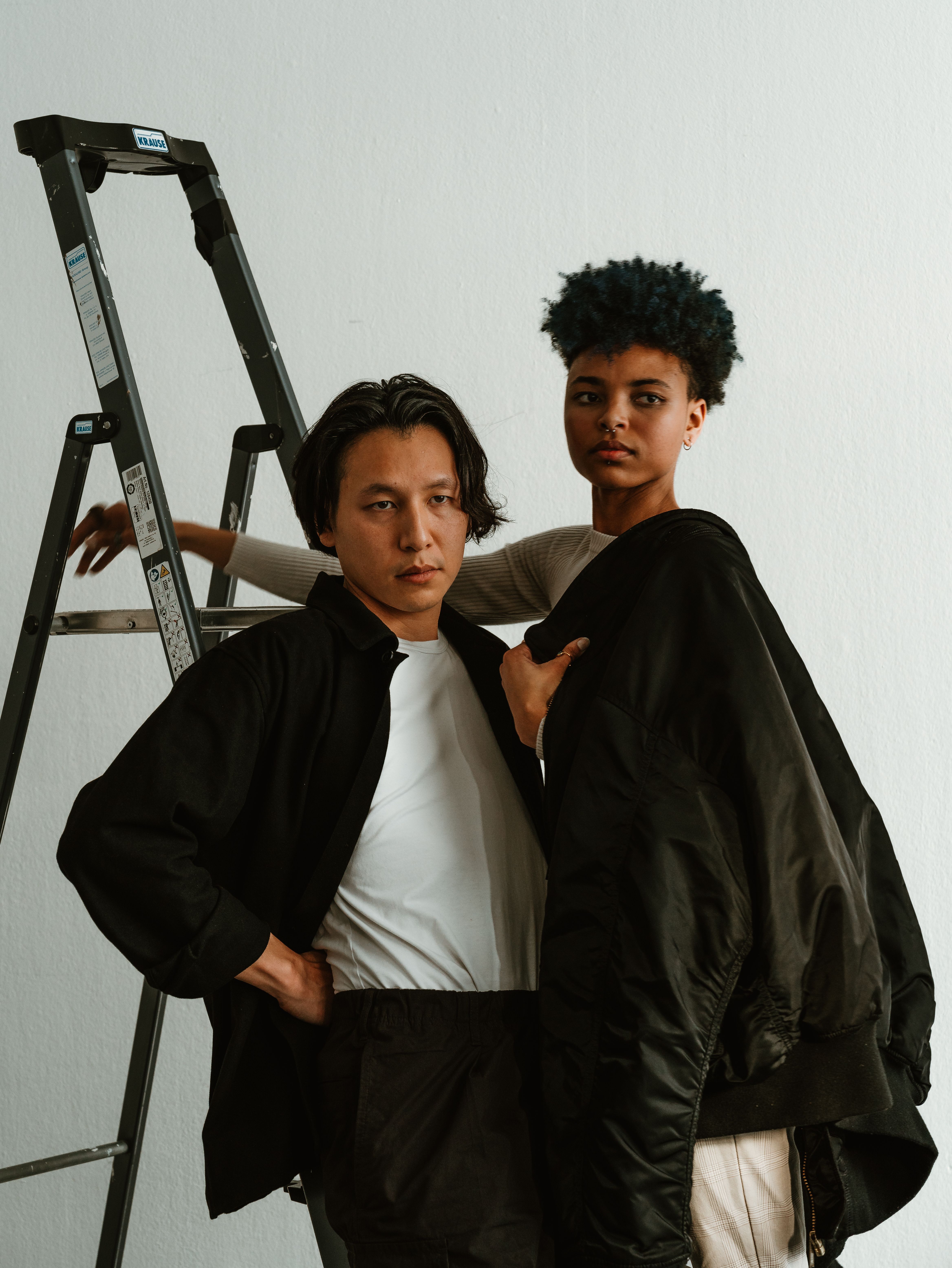 Woman and Man in Jackets Standing by Ladder · Free Stock Photo