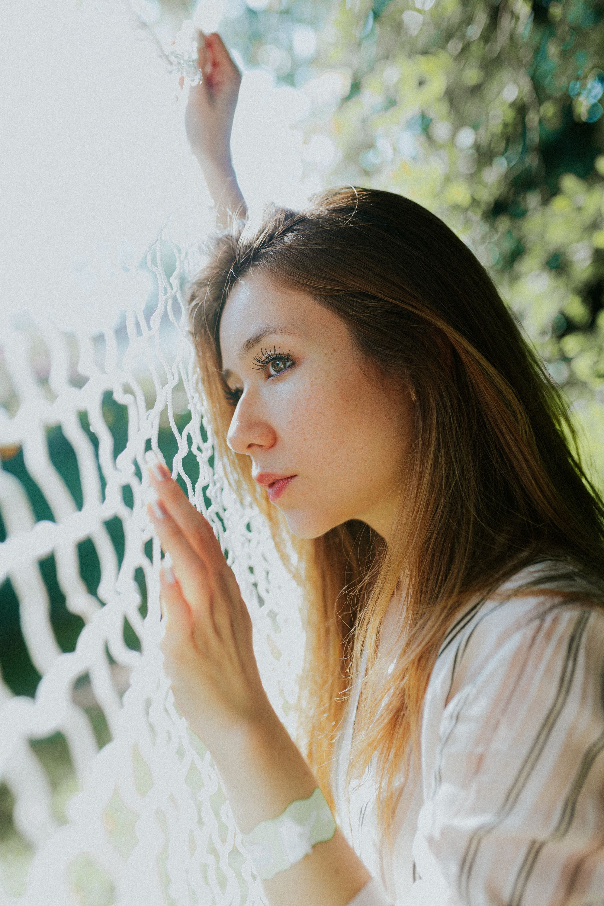 Woman Holding Net with Arm Raised · Free Stock Photo
