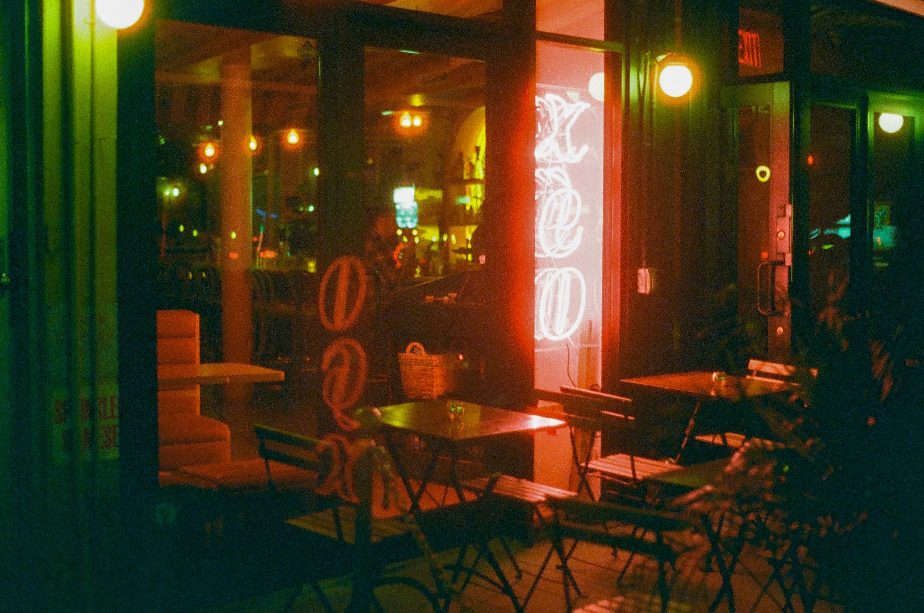 Lights over Restaurant Tables and Chairs at Night · Free Stock Photo