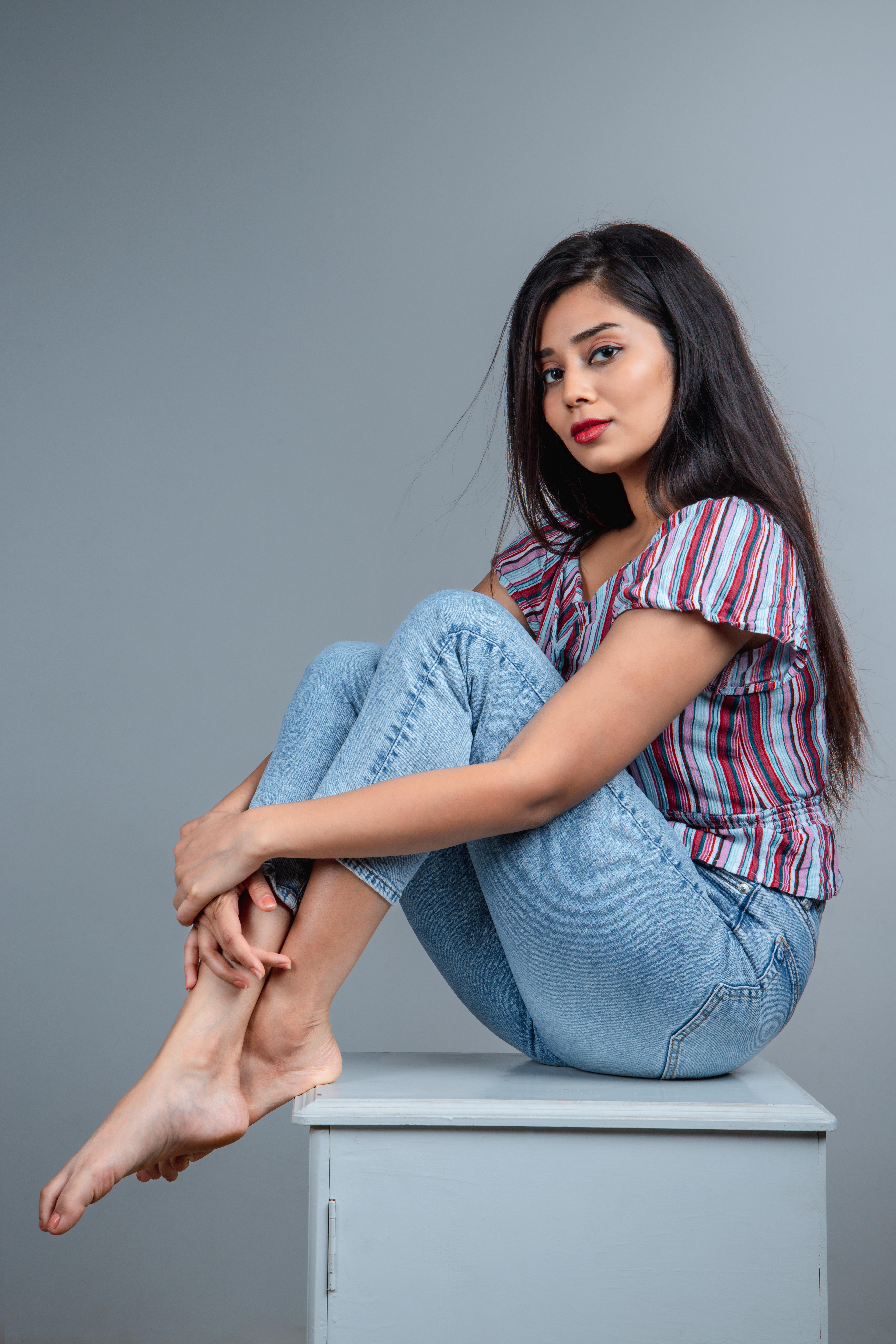 Barefoot Woman in Jeans and Striped Blouse · Free Stock Photo